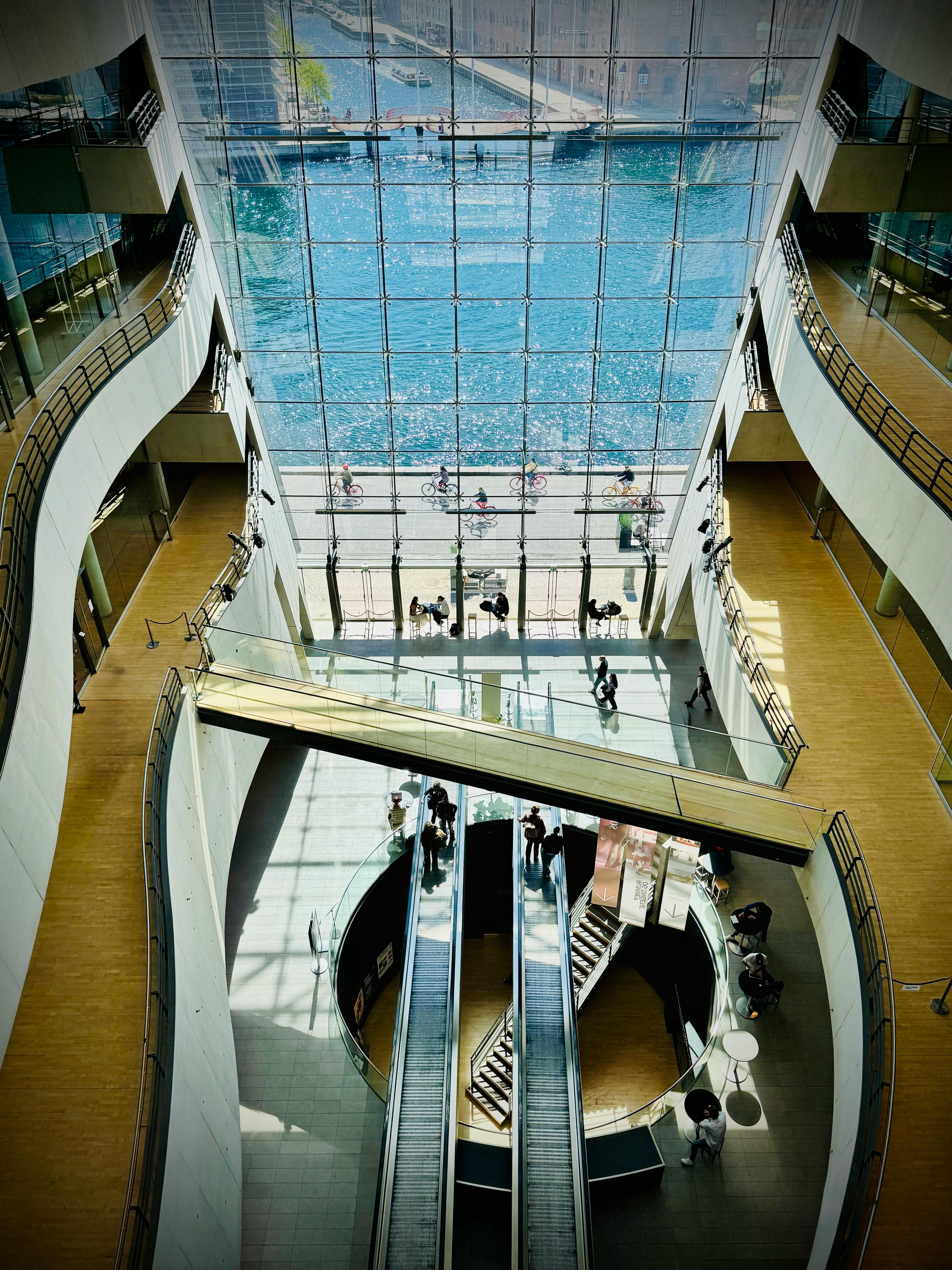 Modern Atrium with Glass Facade and River View · Free Stock Photo
