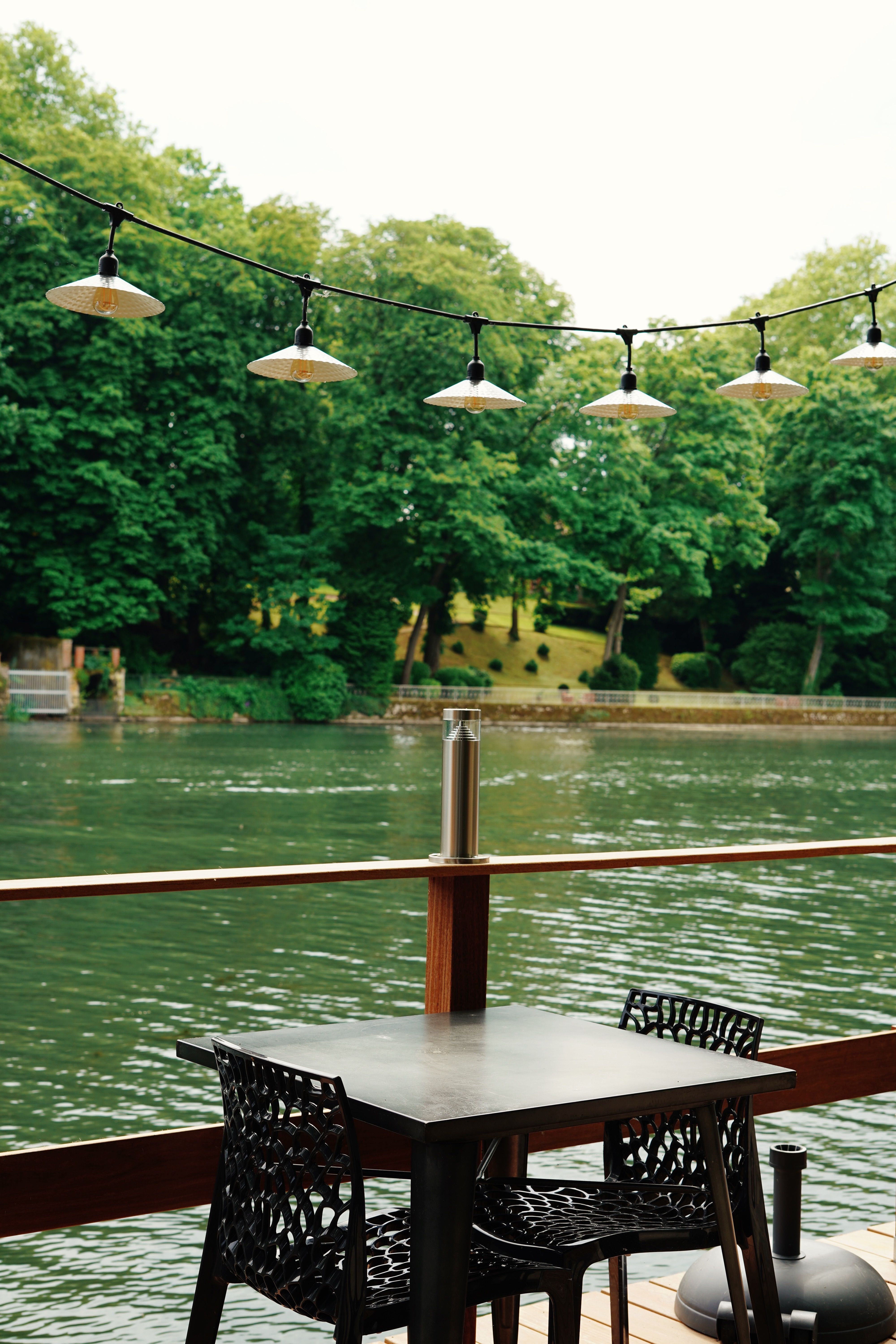 Outdoor Riverside Dining with String Lights · Free Stock Photo
