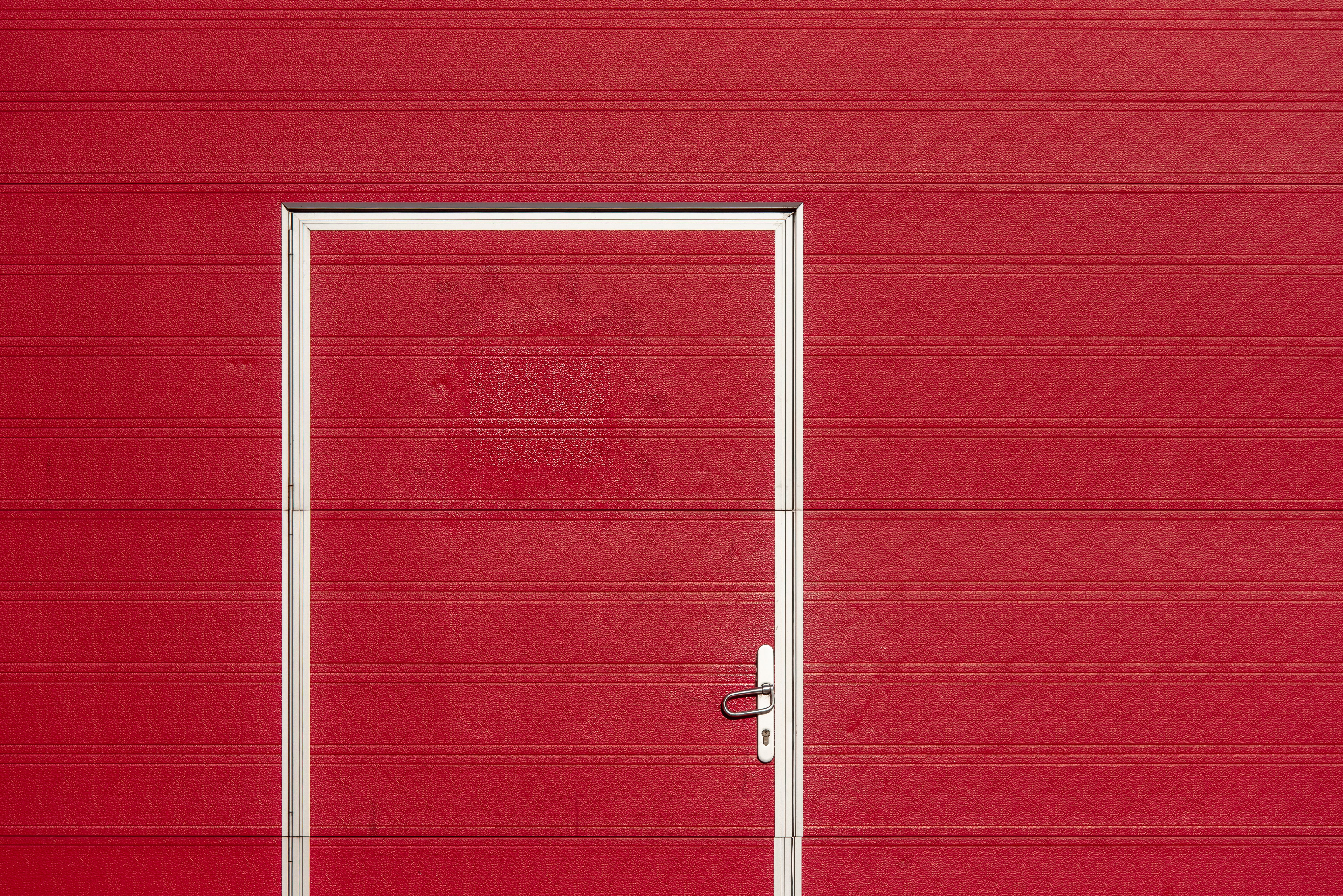 Bright Red Door on Textured Surface · Free Stock Photo