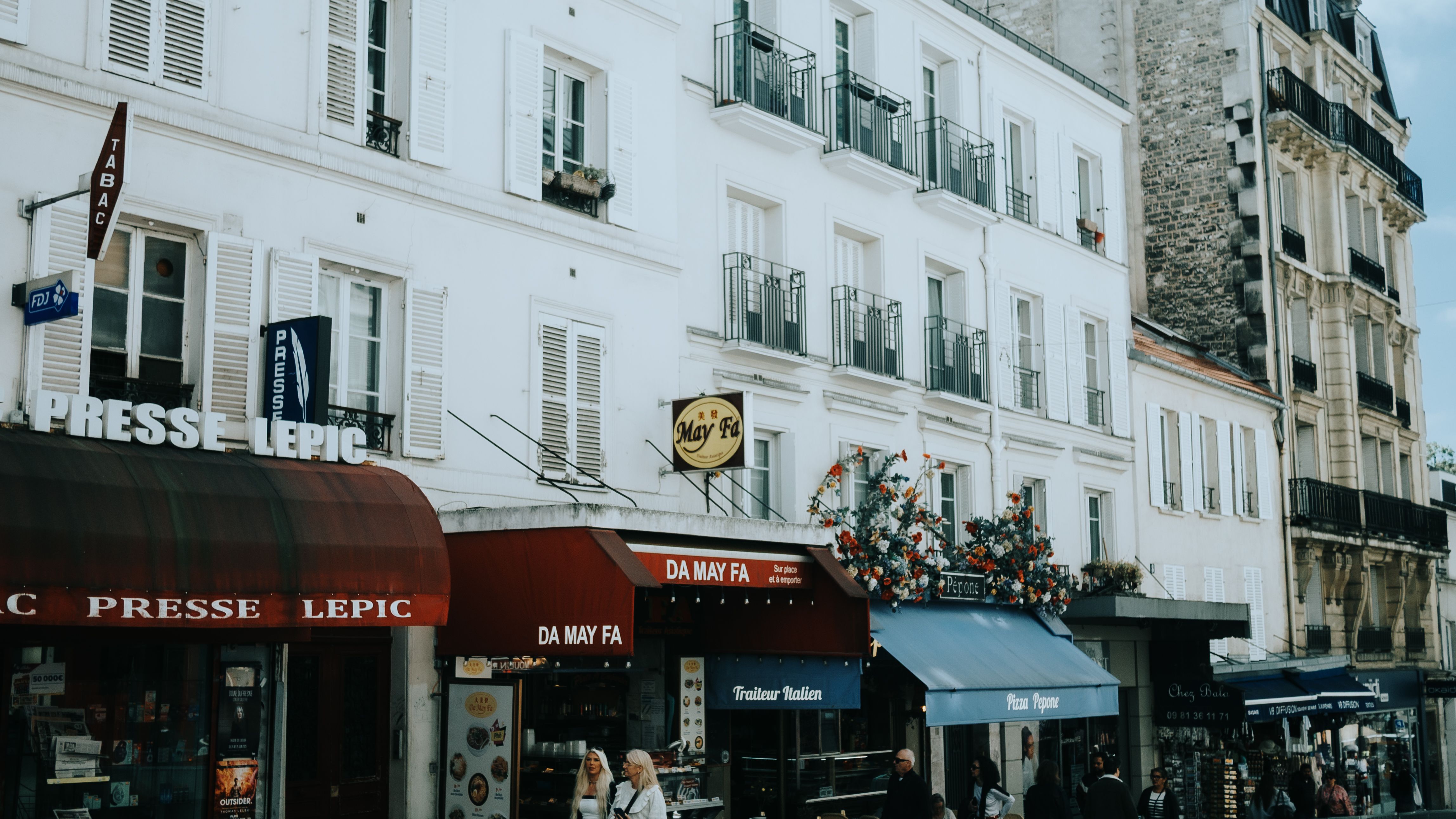 Charming Parisian Street Scene with Cafes · Free Stock Photo