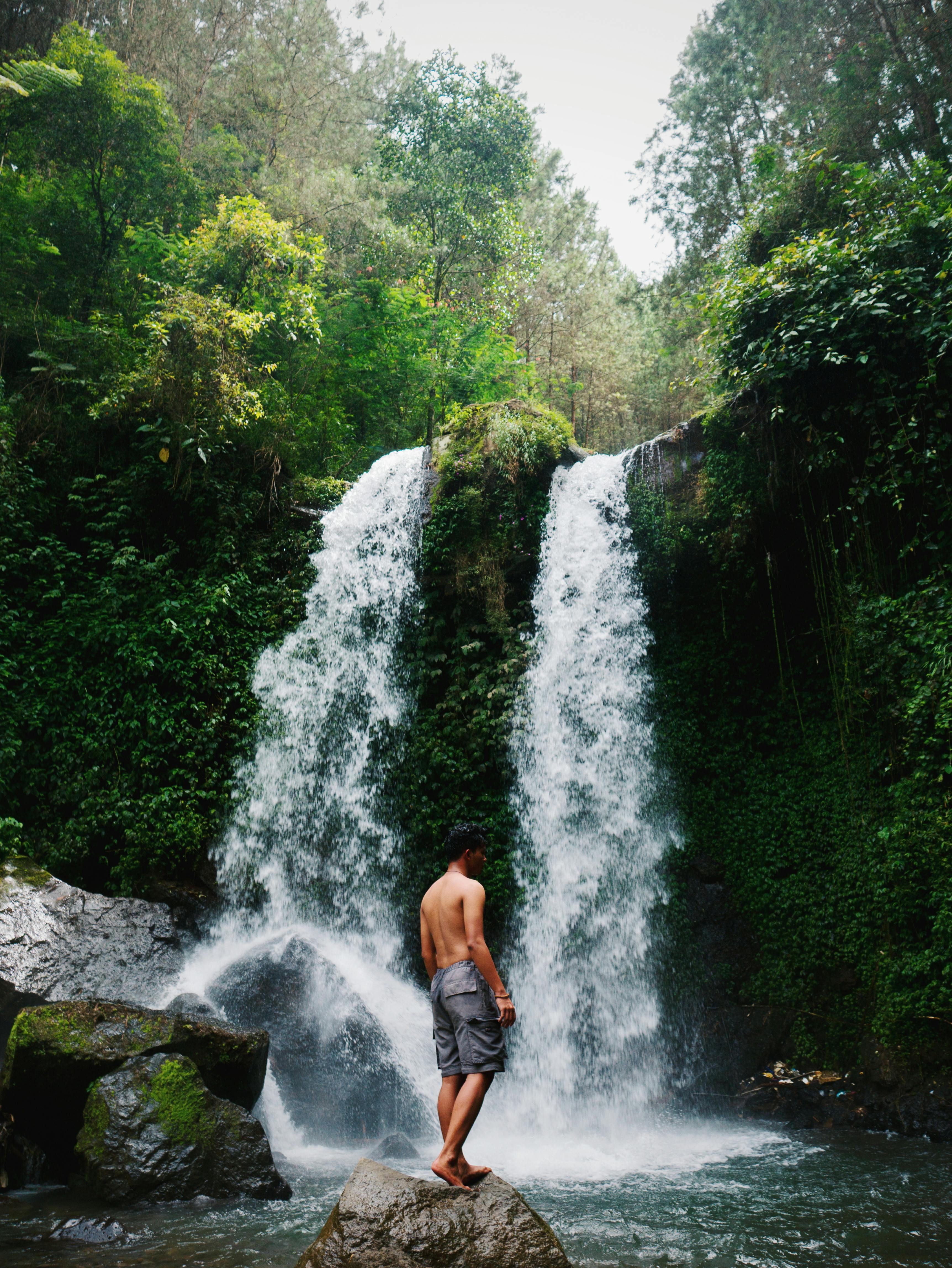 Man Standing Near Waterfalls · Free Stock Photo