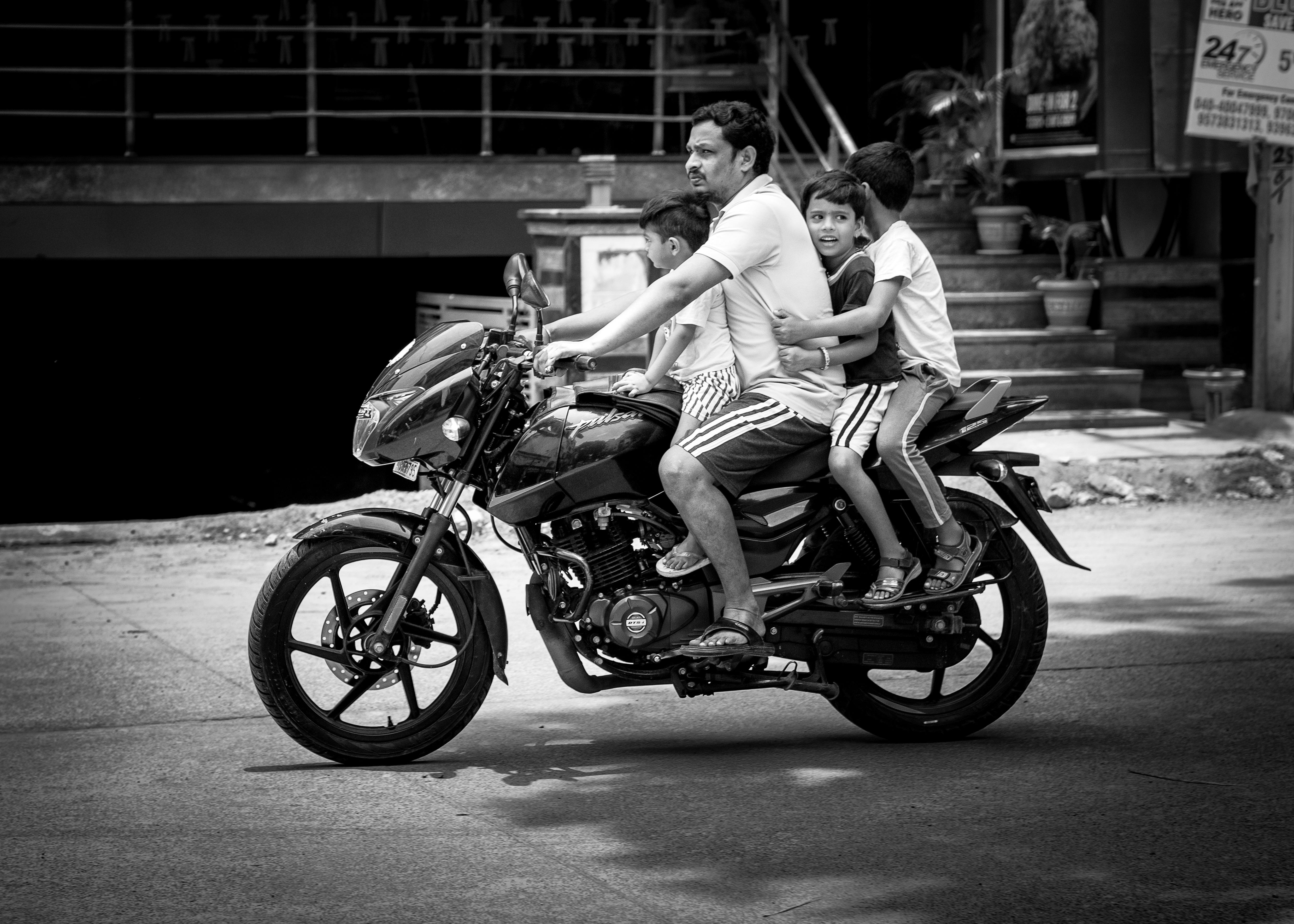 Father and Children Riding Motorcycle in Urban Setting · Free Stock Photo