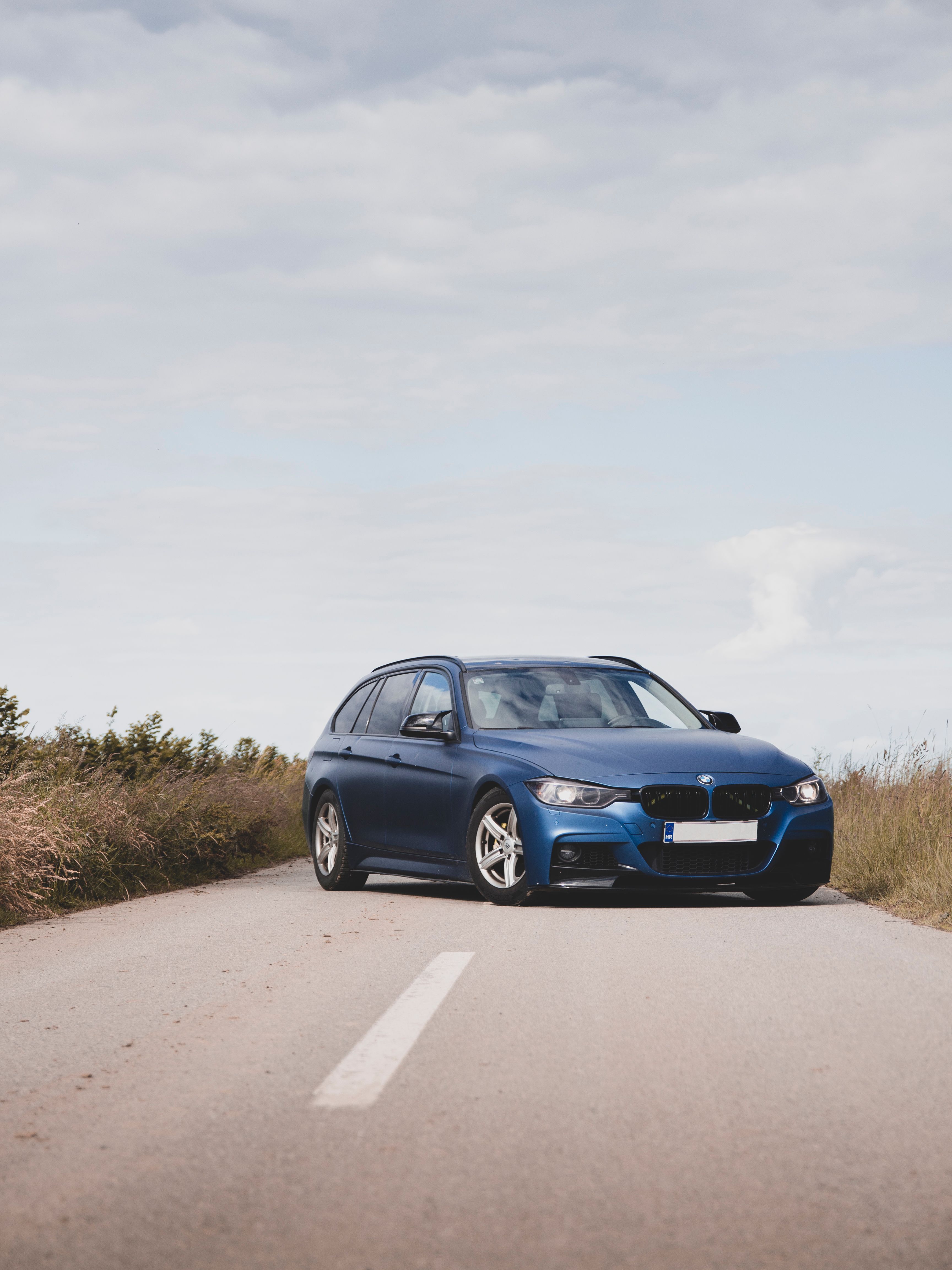 Blue Car on Open Road Under Clear Sky · Free Stock Photo