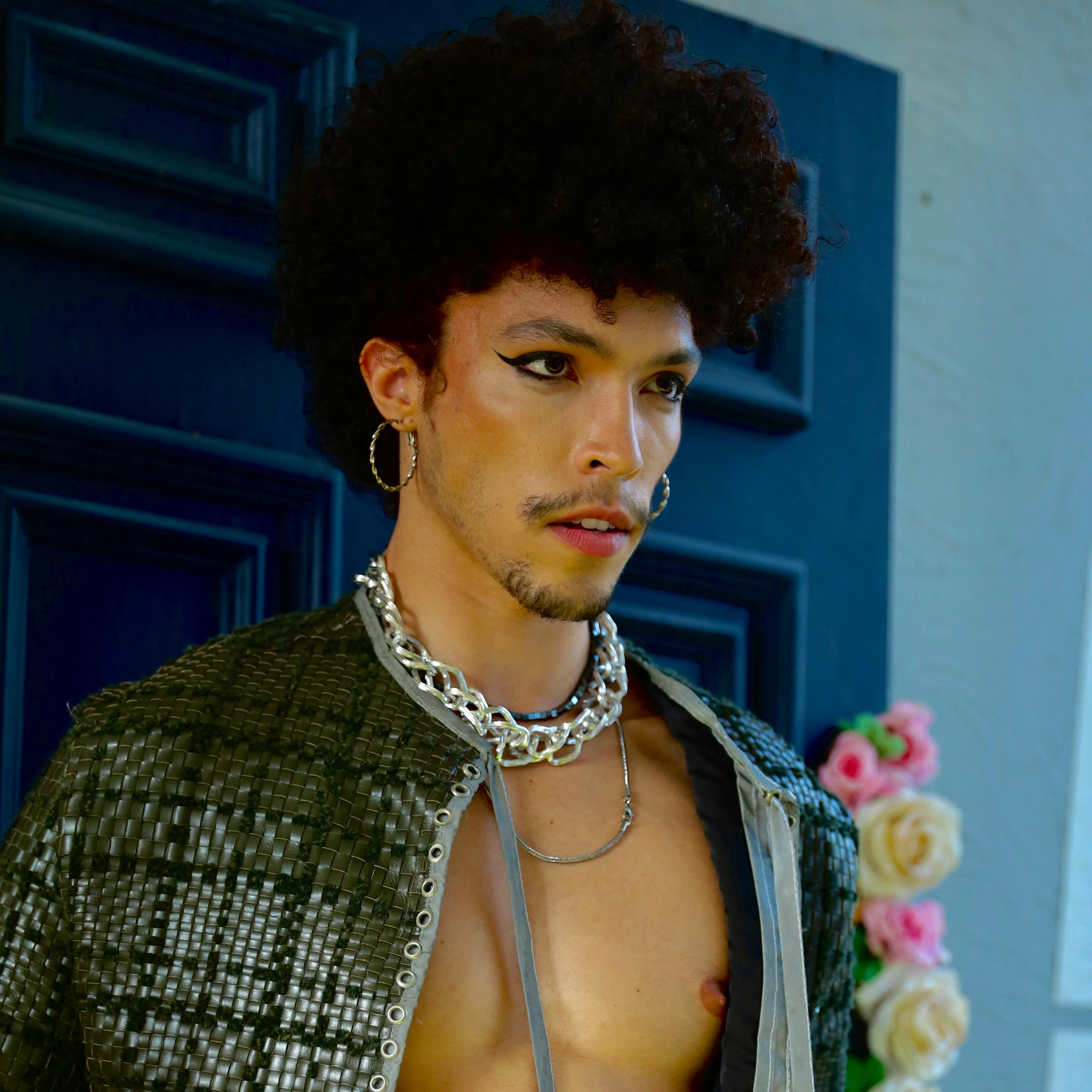 Fashionable Individual with Bold Makeup and Chains · Free Stock Photo