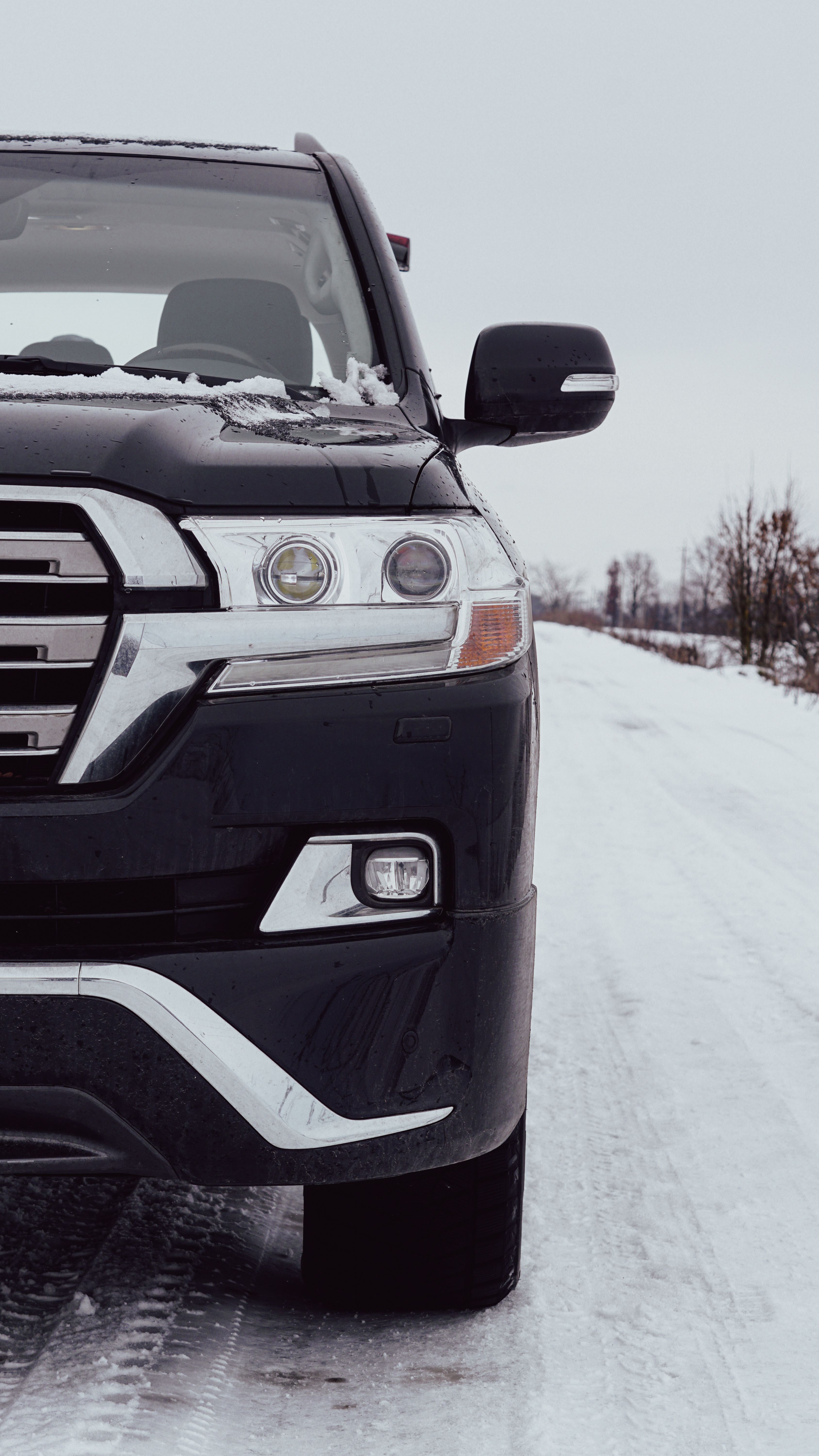 Black SUV on Snow-Covered Road in Winter Scene · Free Stock Photo