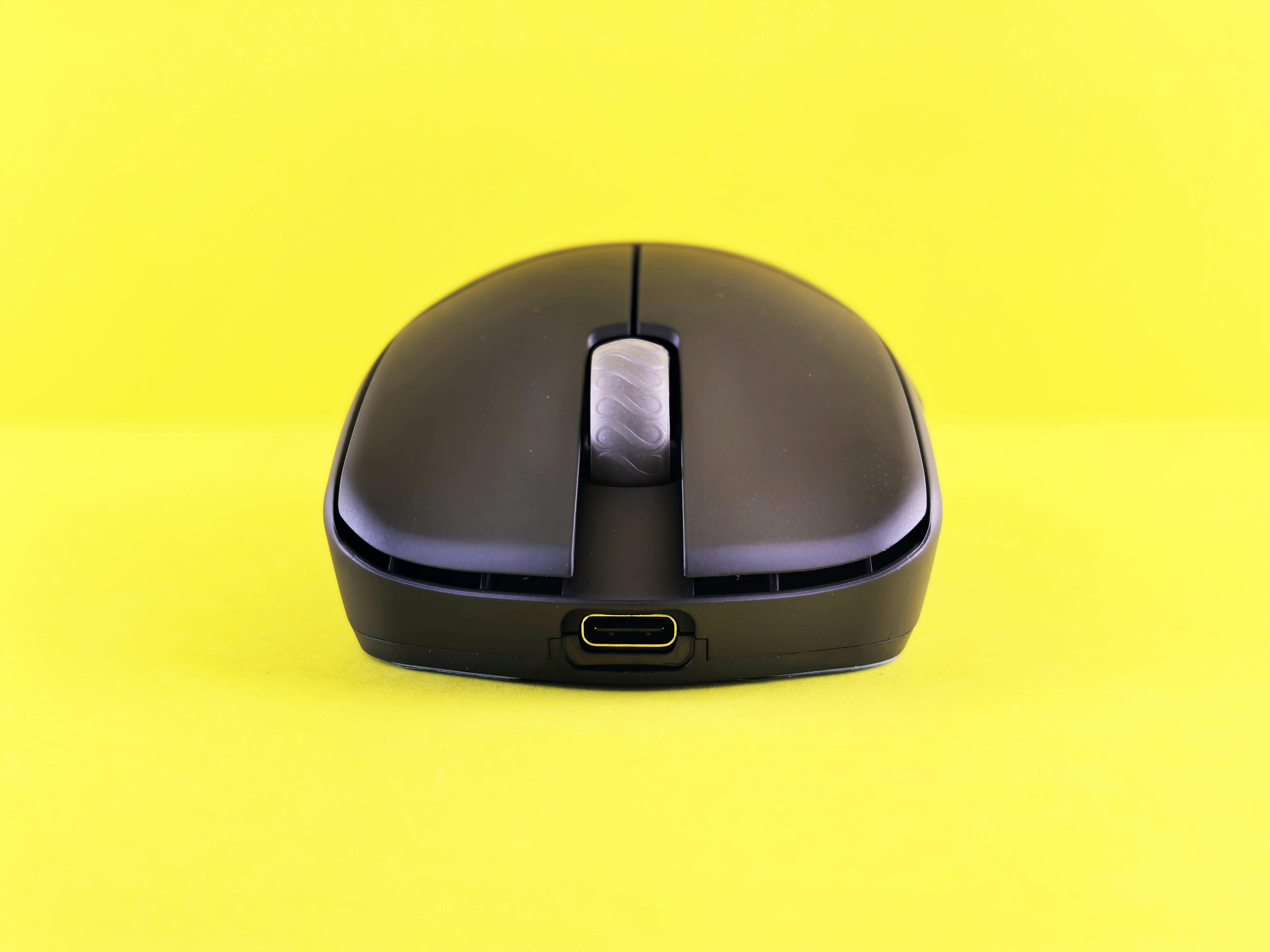 Sleek Wireless Mouse on Vibrant Yellow Background · Free Stock Photo