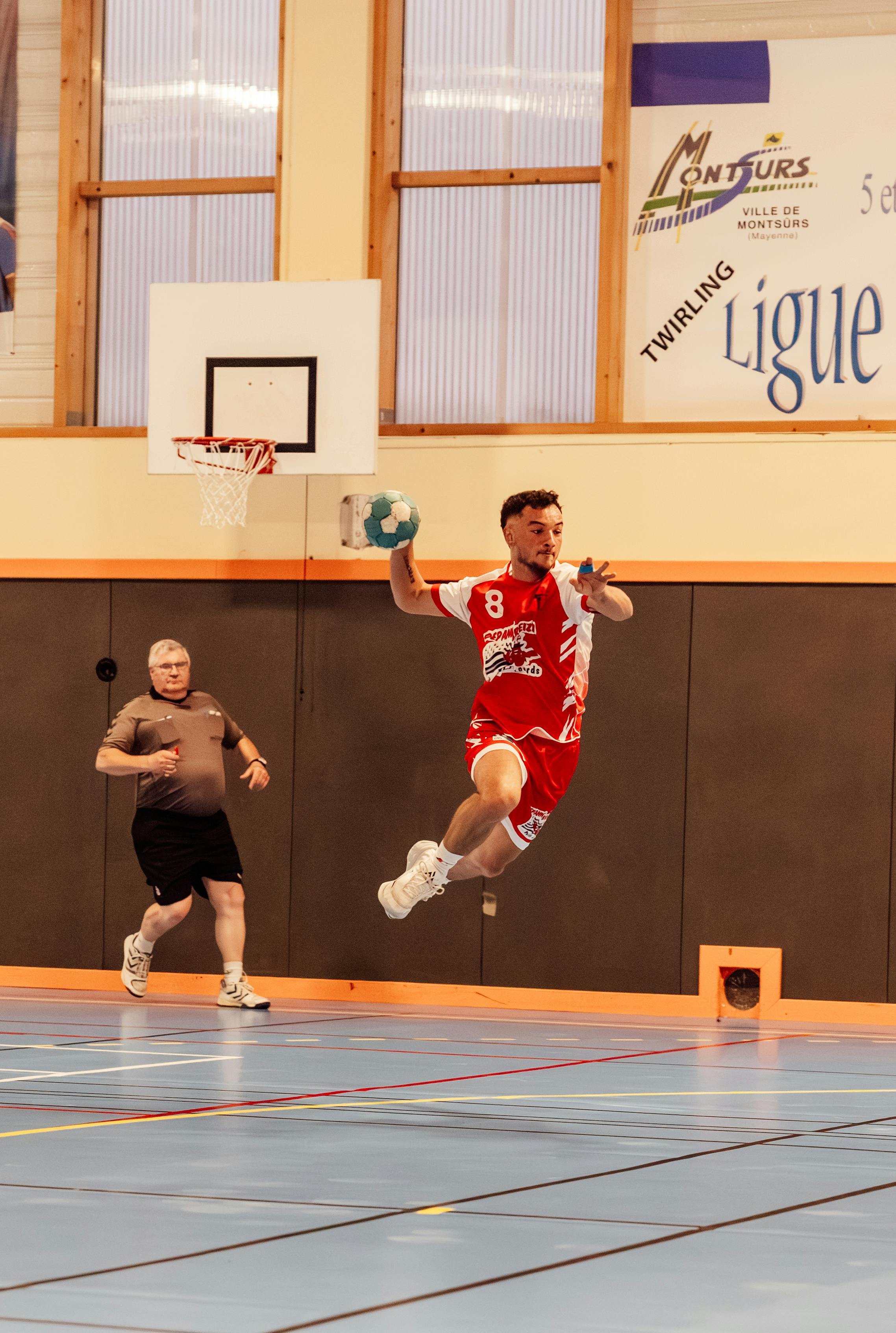 Dynamic Handball Match in Indoor Sports Arena · Free Stock Photo