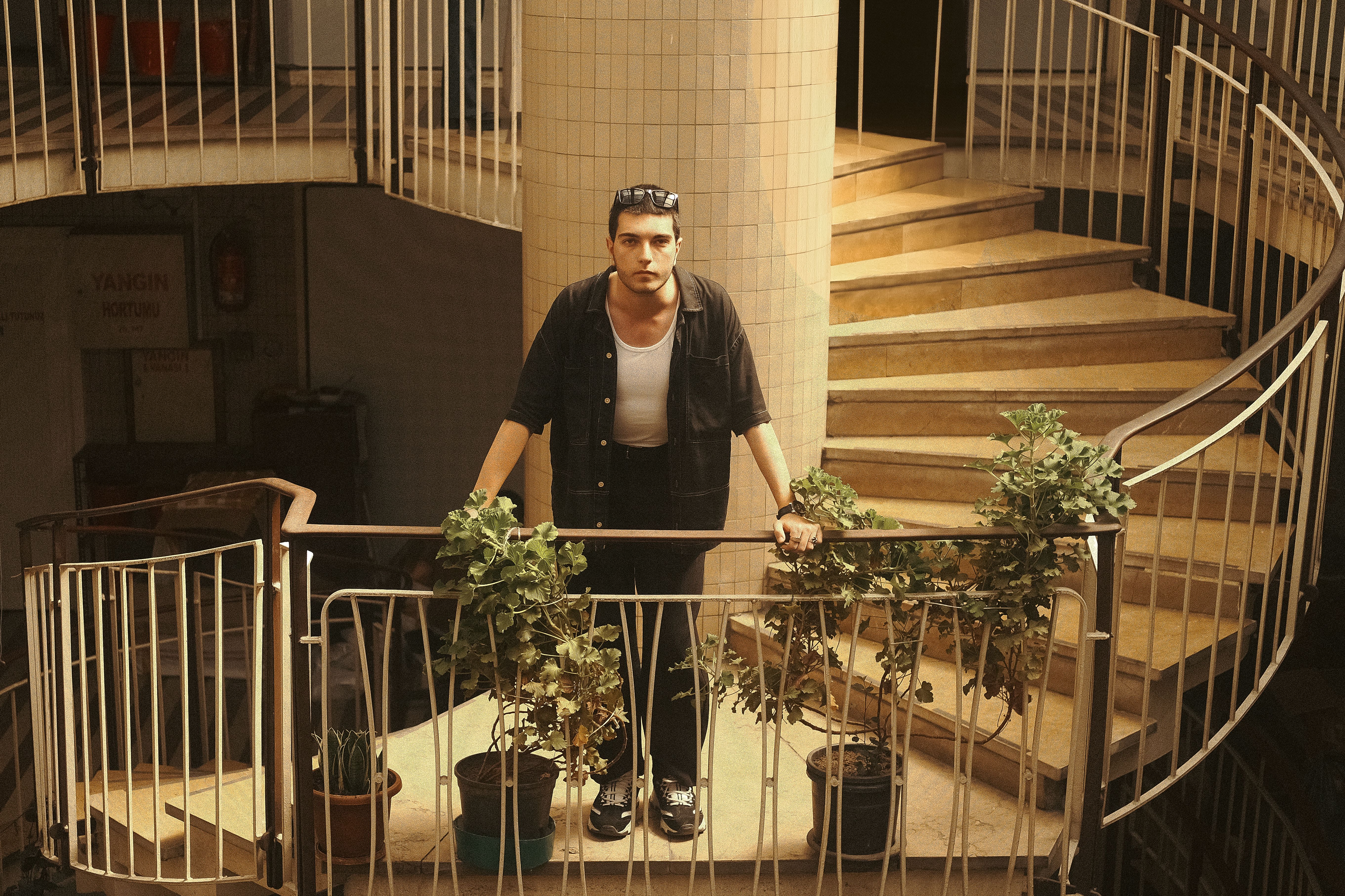 Stylish Man in Modern Indoor Spiral Staircase · Free Stock Photo