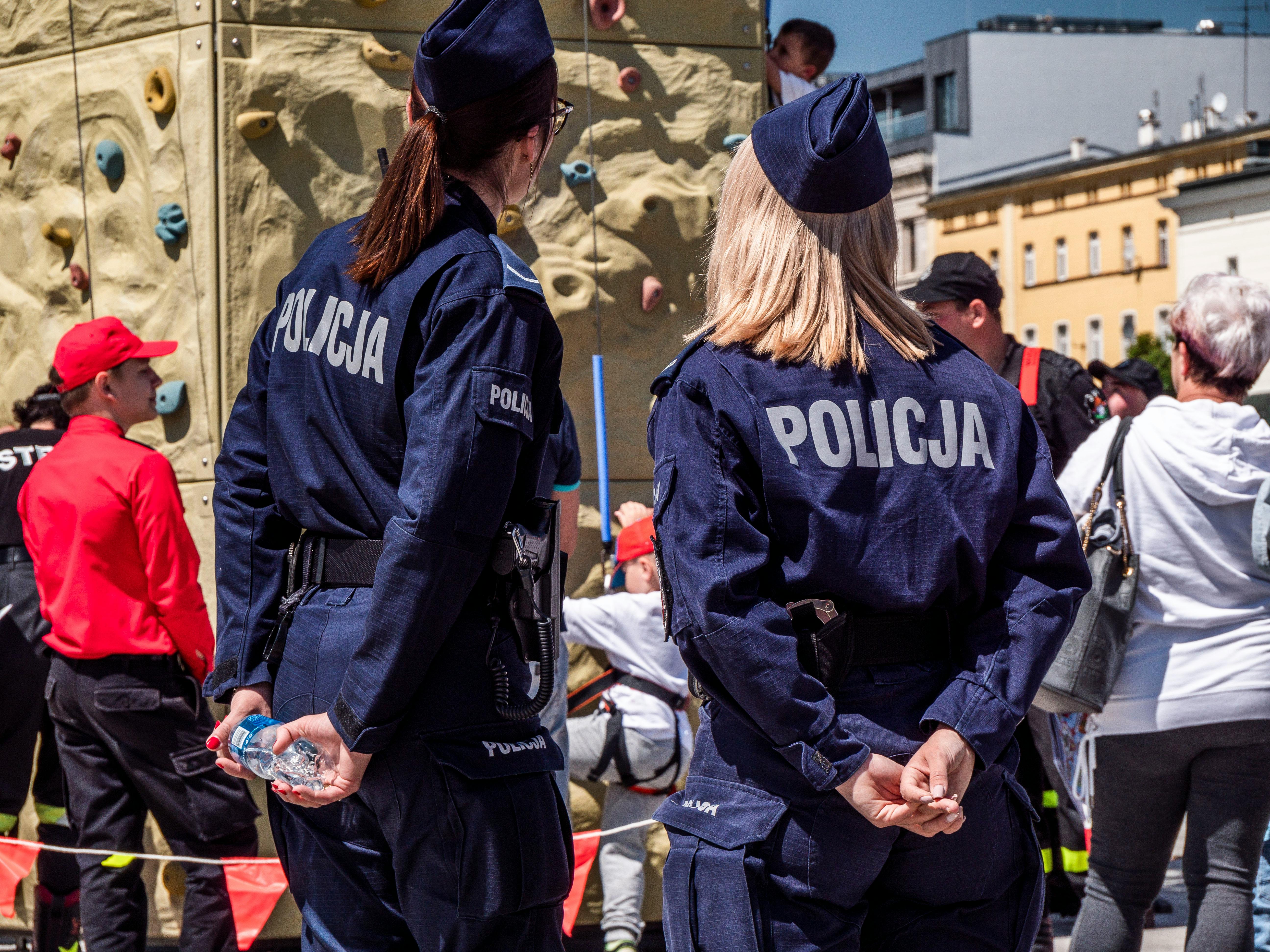 Police Officers Overseeing Outdoor Climbing Event · Free Stock Photo