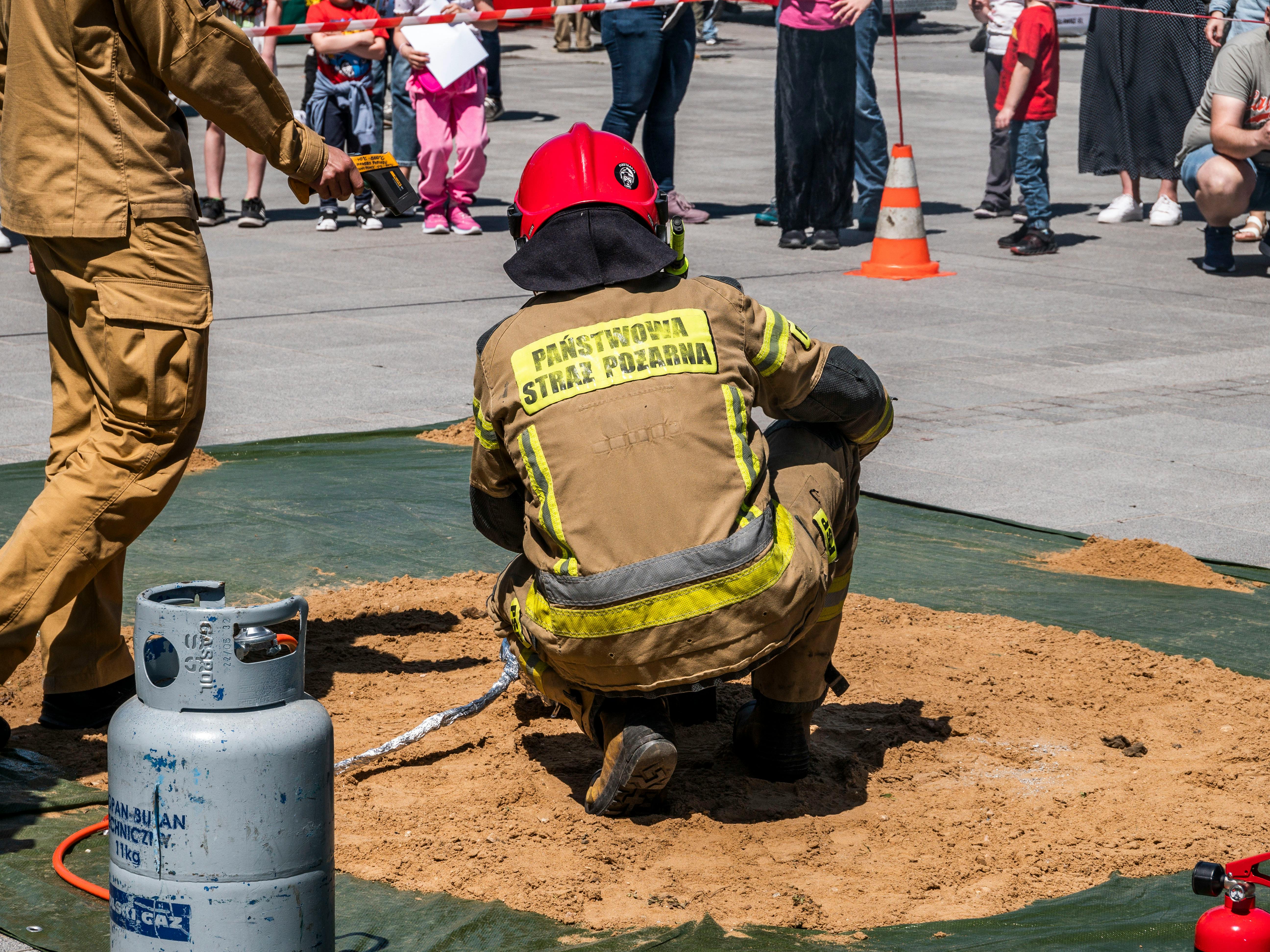 Firefighters Demonstrating Safety Techniques Outdoors · Free Stock Photo