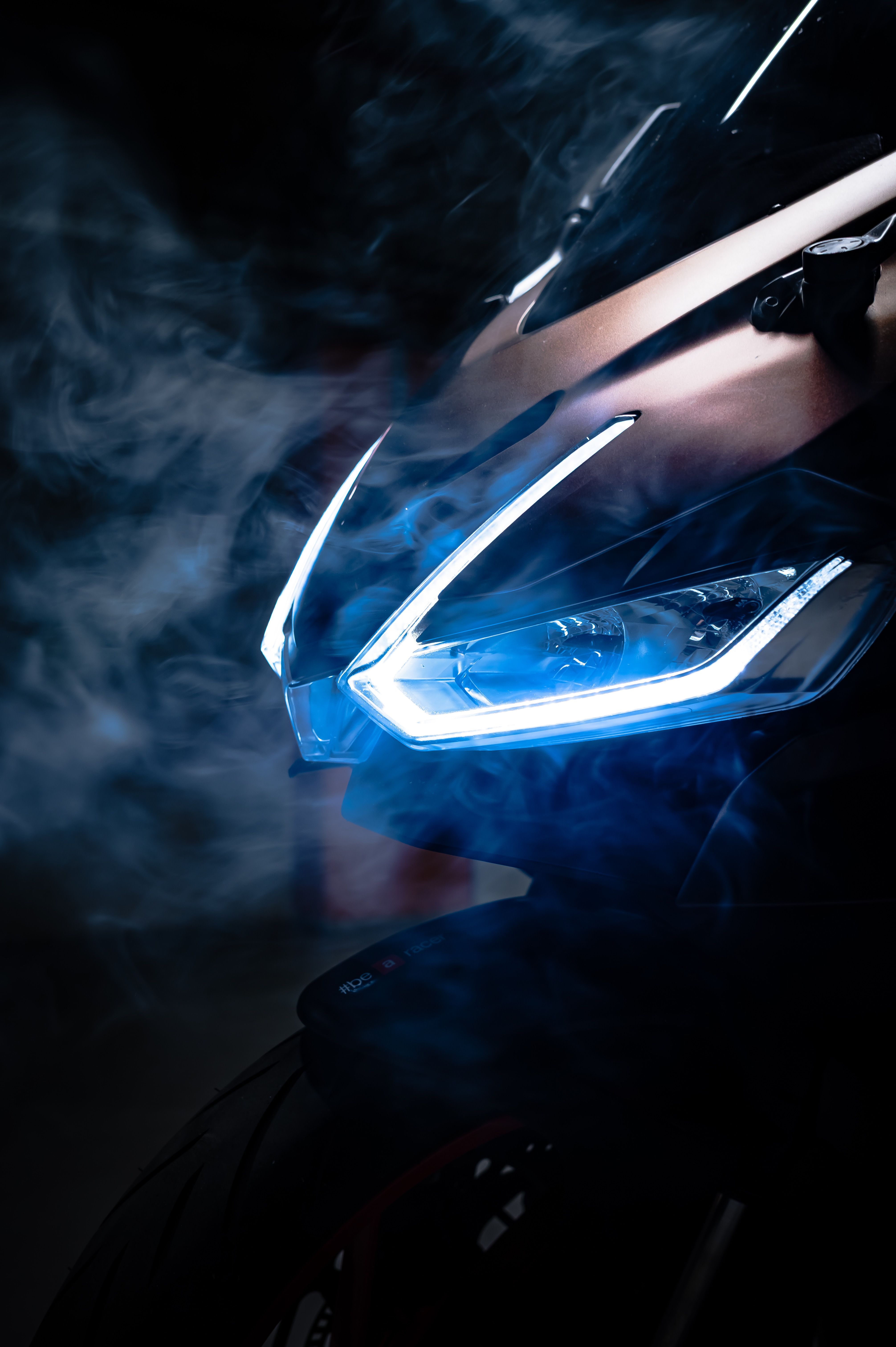 Futuristic Motorcycle Headlight in Smoky Environment · Free Stock Photo