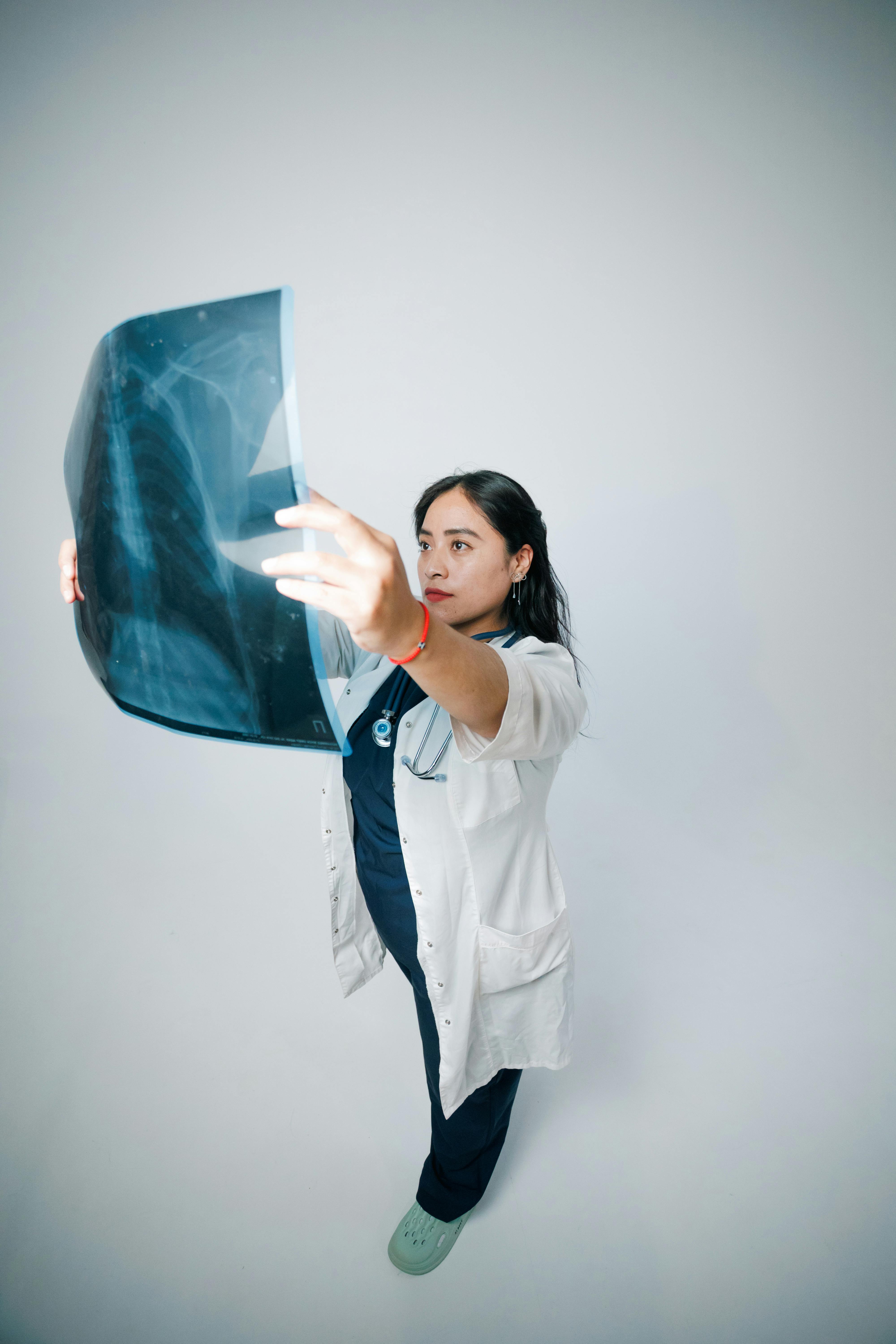 Female Doctor Analyzing X-ray with Care · Free Stock Photo