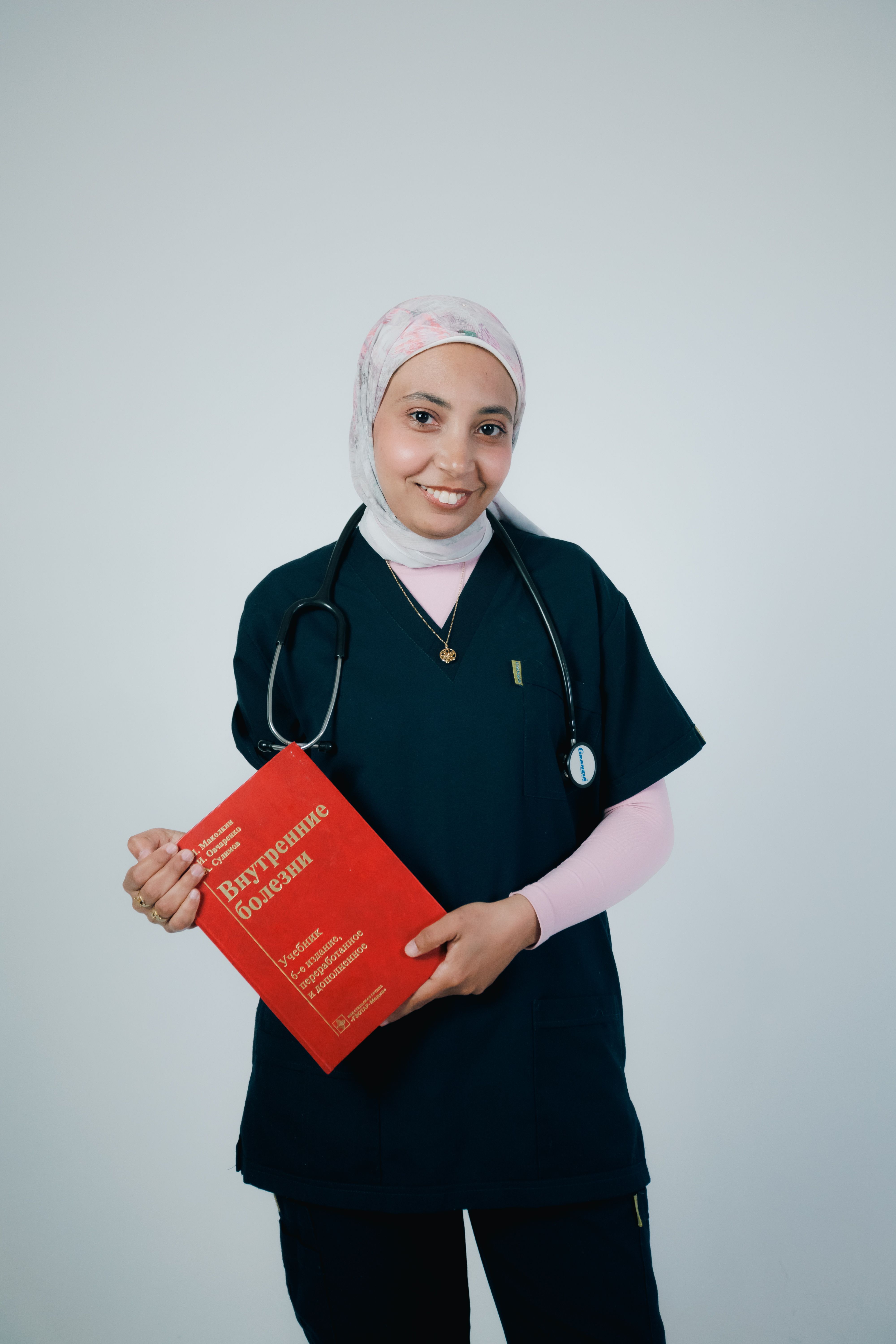 Female Doctor Holding Medical Book in Studio · Free Stock Photo