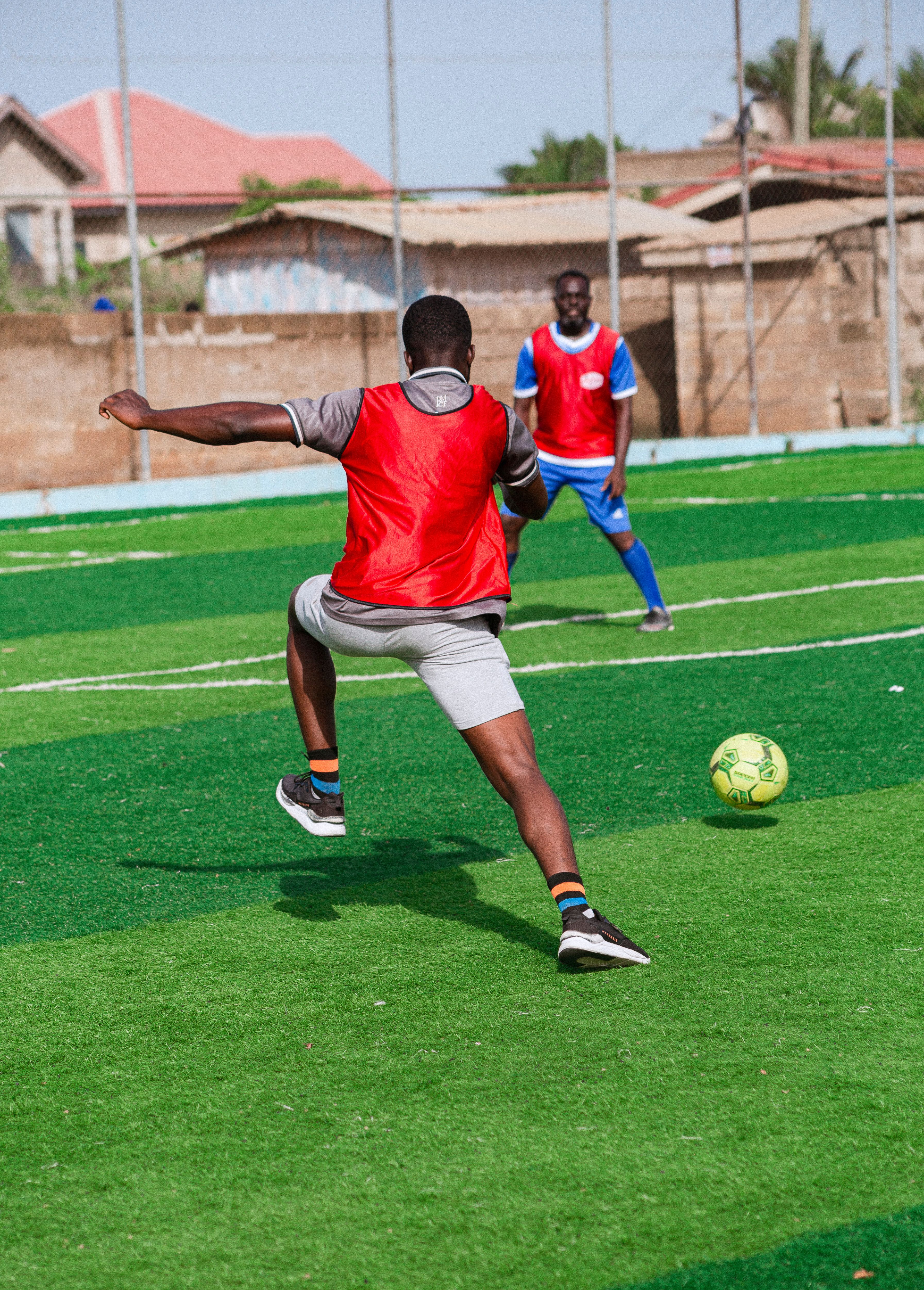 Outdoor Soccer Game with Players on Green Field · Free Stock Photo