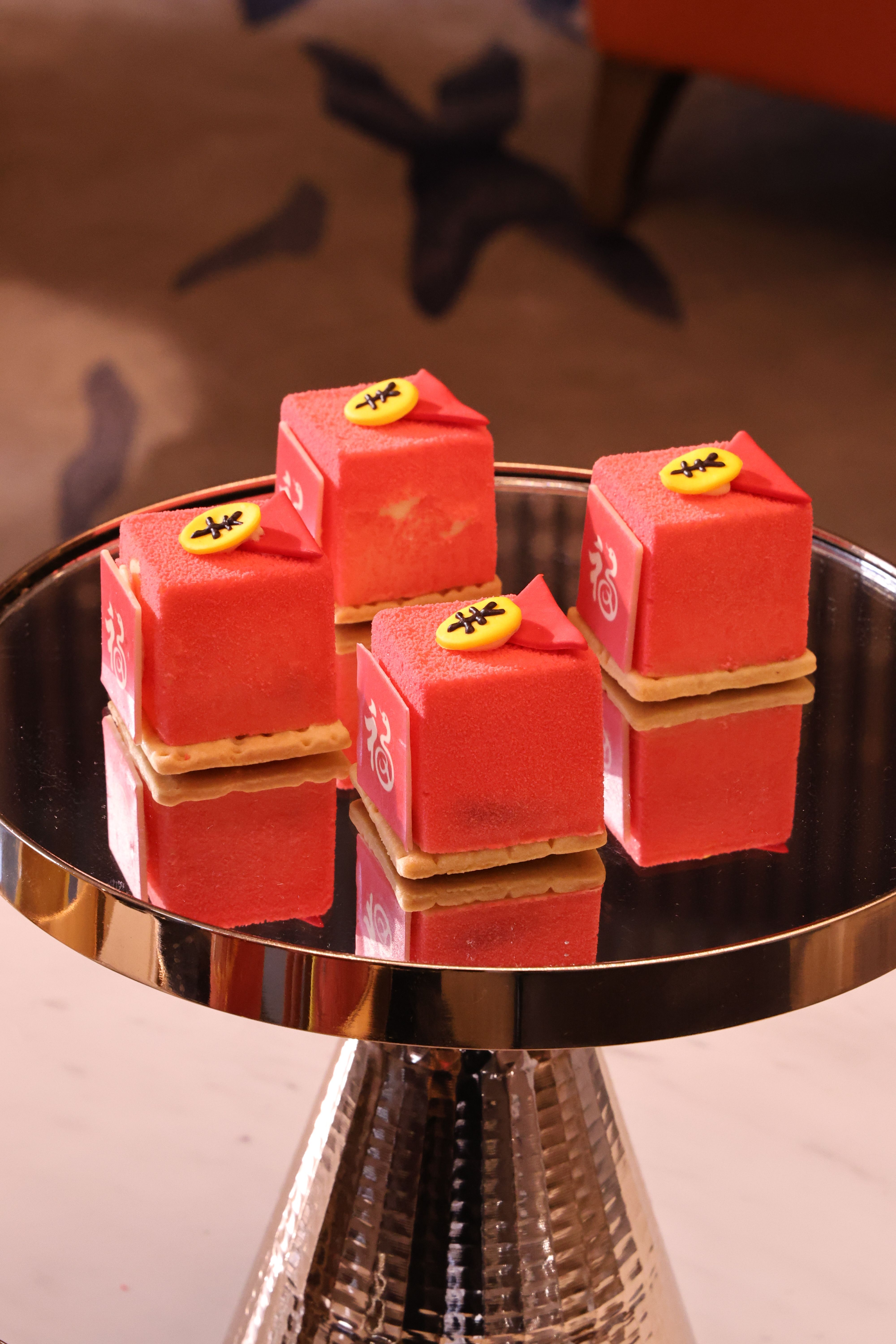 Elegant Red Pastries on Reflective Stand · Free Stock Photo