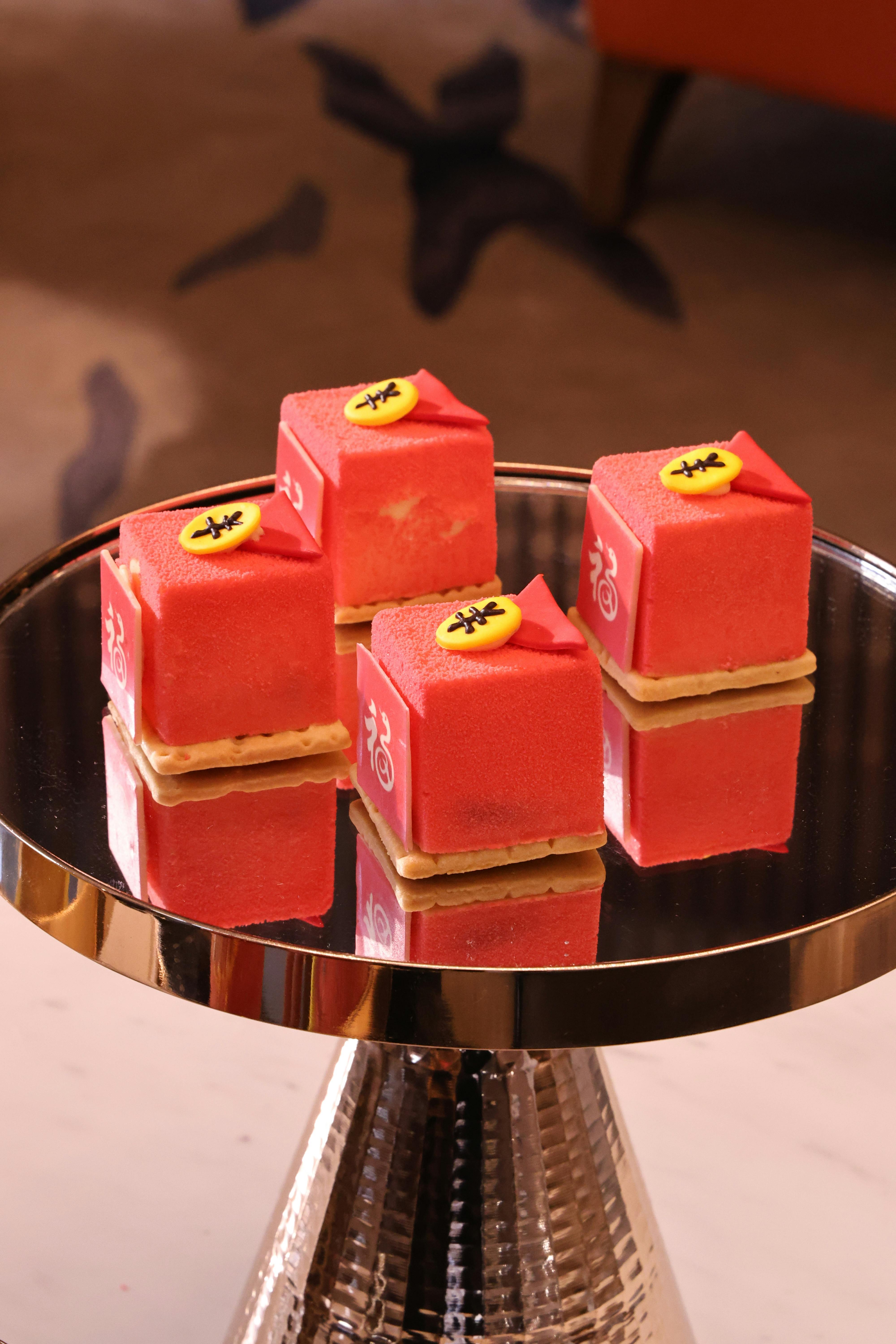 Elegant Red Pastries on Reflective Stand · Free Stock Photo