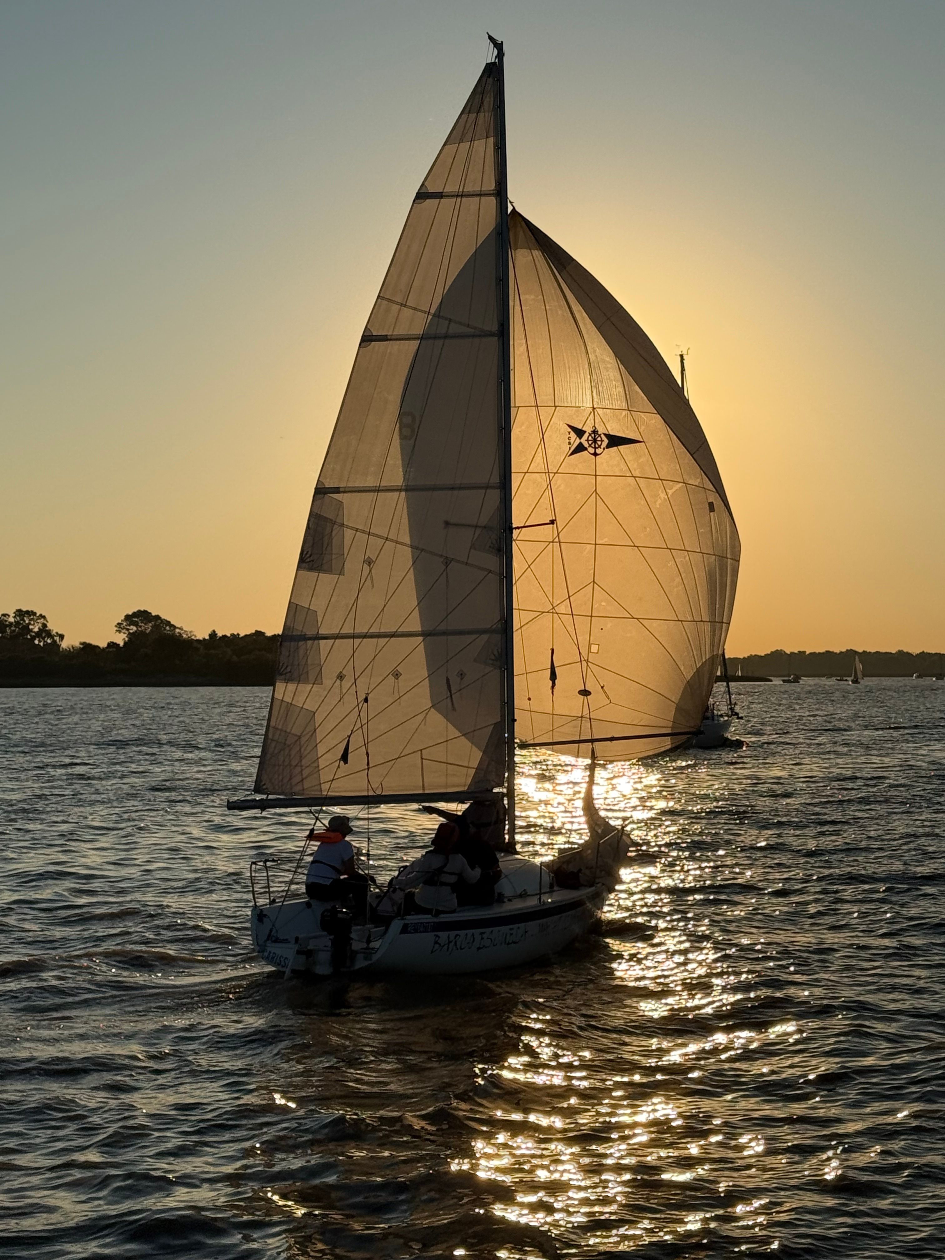 Sailing Boat at Sunset on a Tranquil River · Free Stock Photo