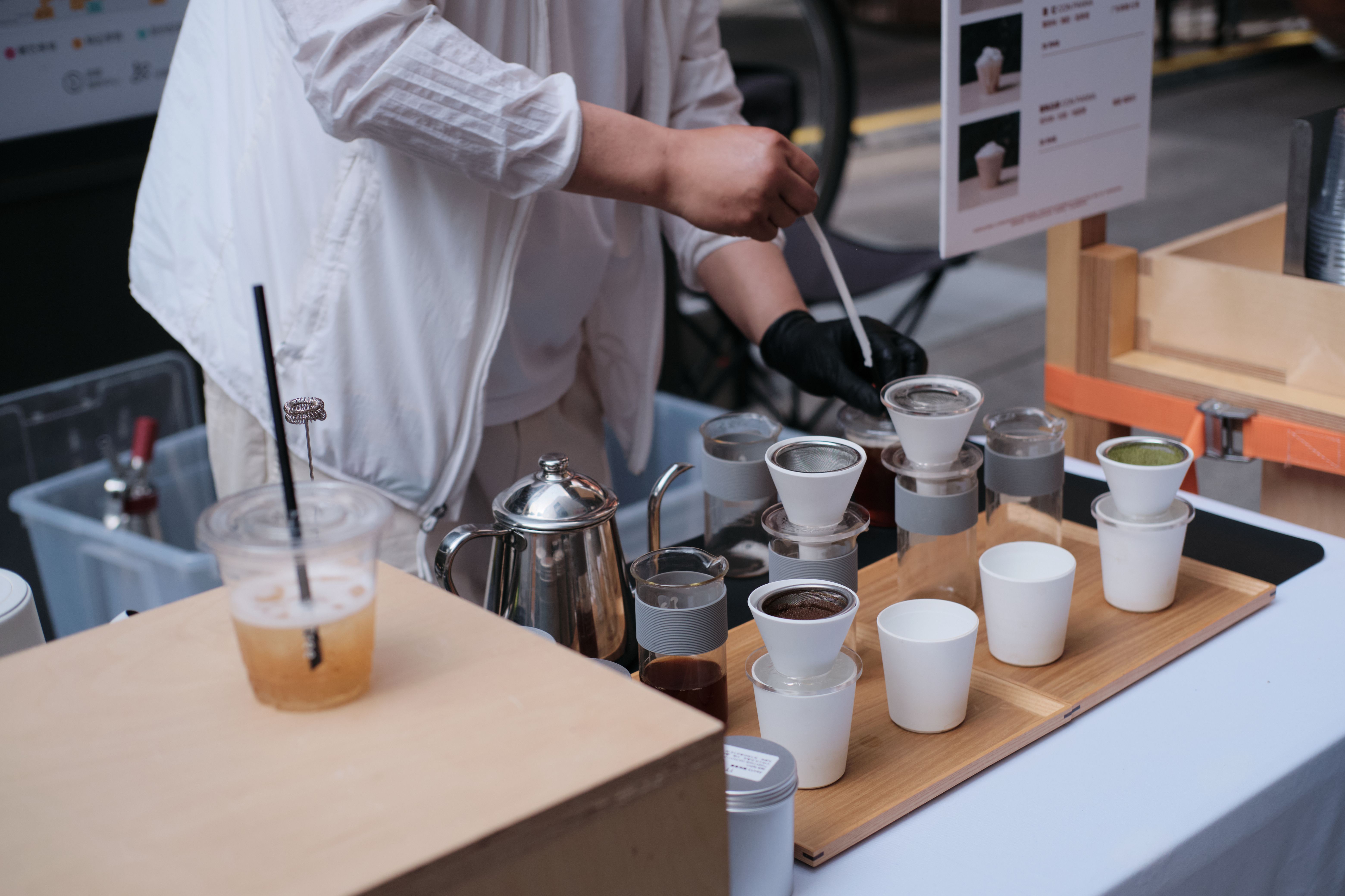 Outdoor Coffee Brewing Station with Barista · Free Stock Photo