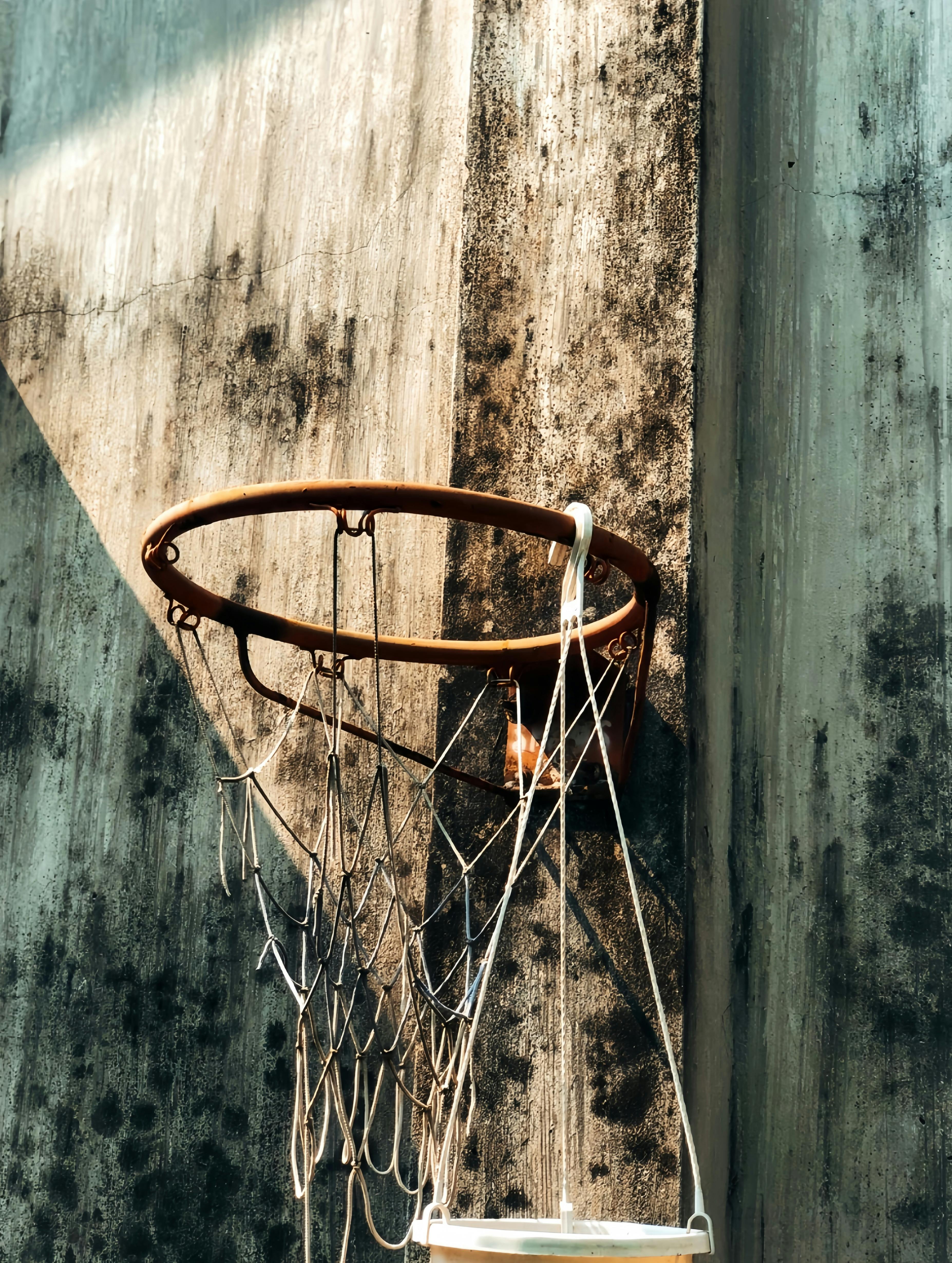 Rusty Basketball Hoop with Shadow and Weathered Wall · Free Stock Photo