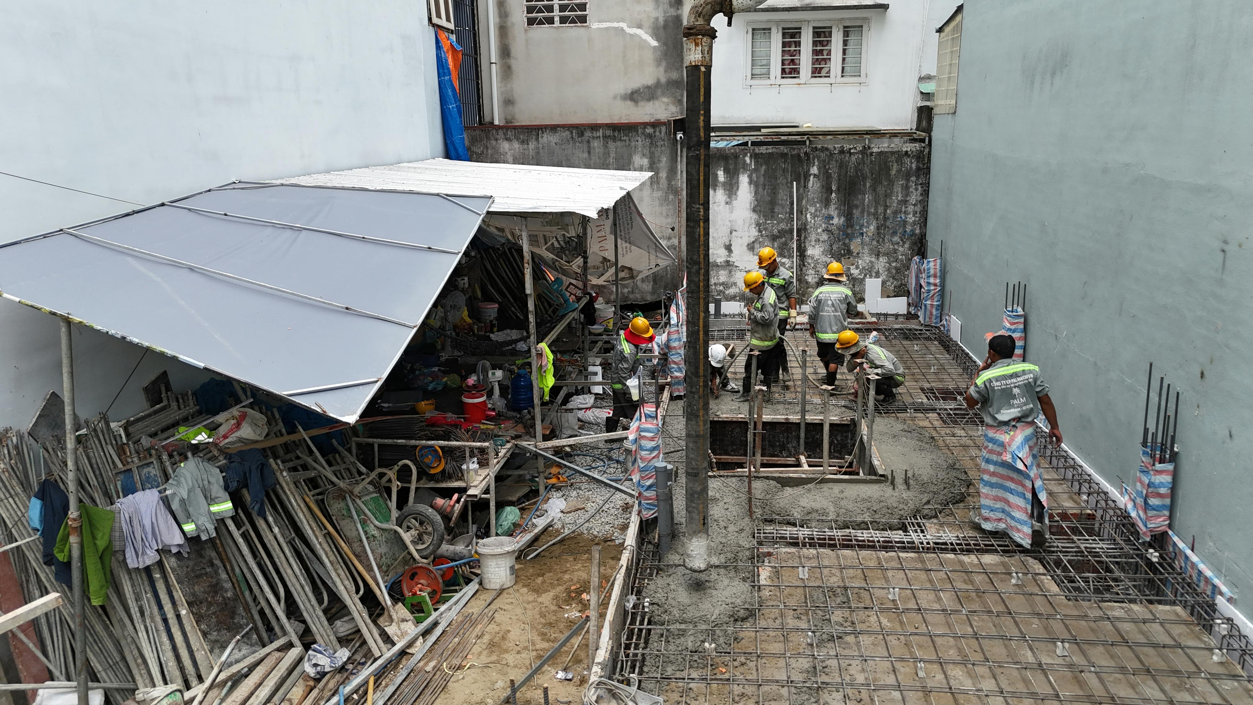 Urban Construction Site with Workers in Helmets · Free Stock Photo