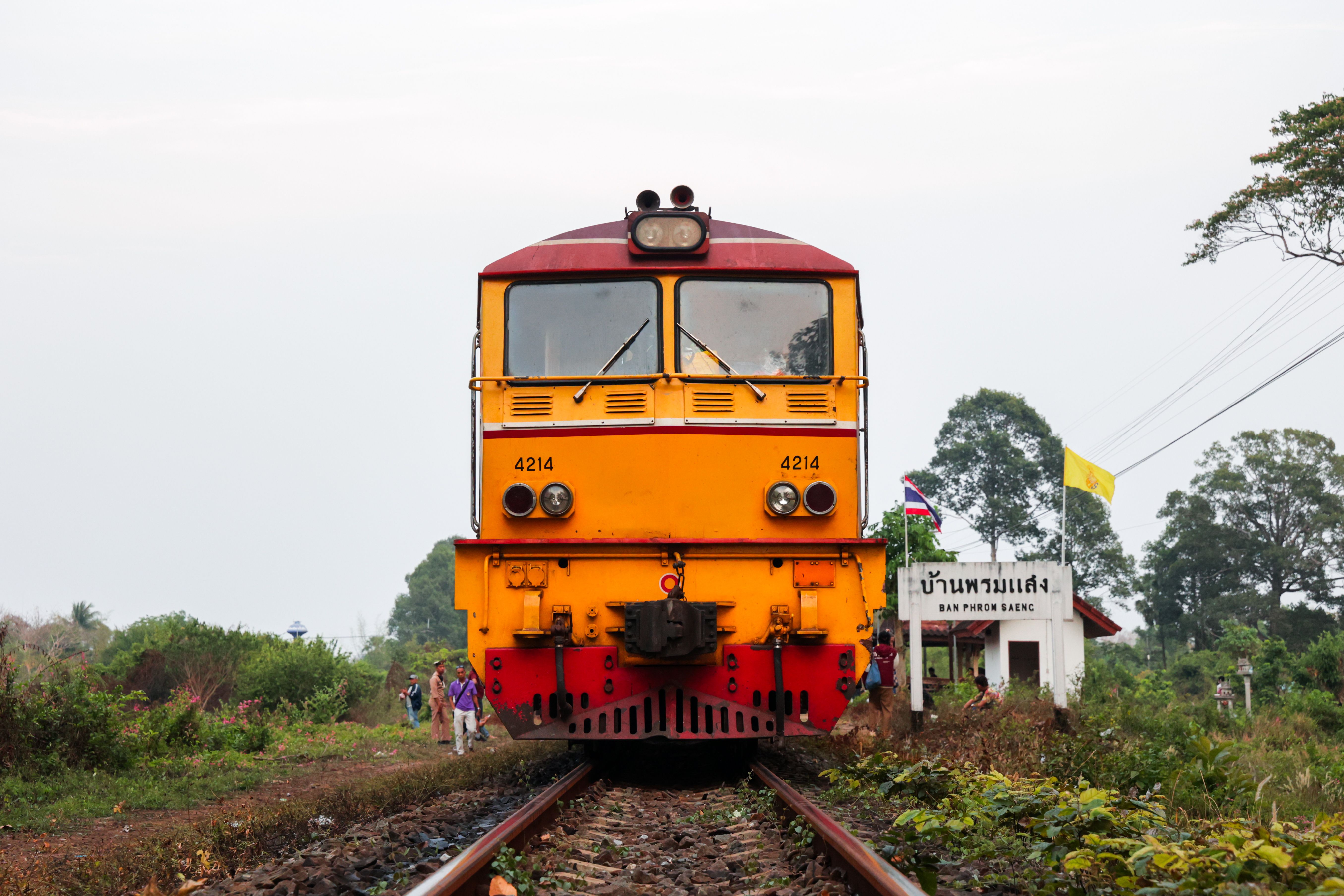 Vibrant Yellow Train on Rural Tracks · Free Stock Photo