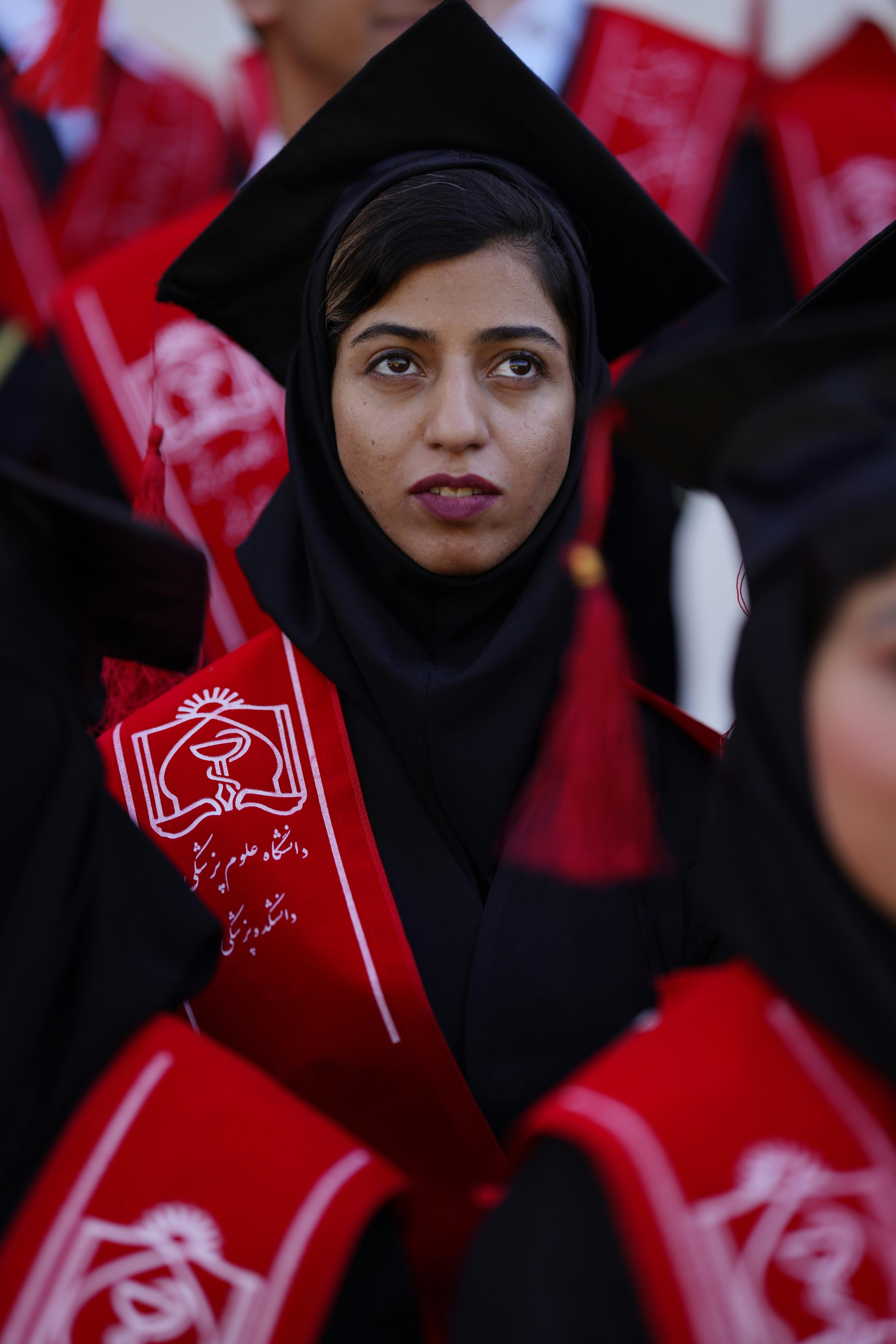 Young Woman in Graduation Gown at Ceremony · Free Stock Photo