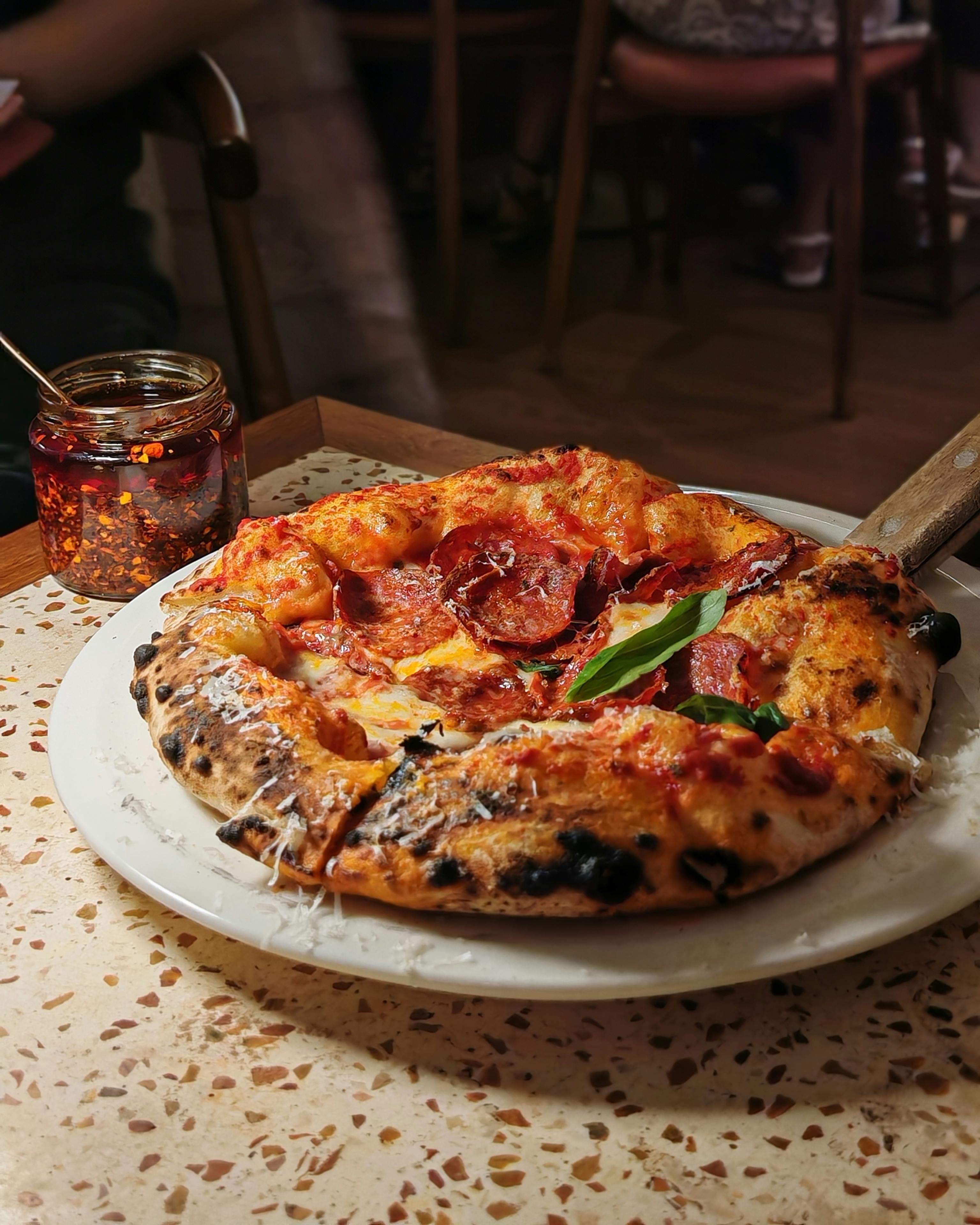 Delicious Pepperoni Pizza in Restaurant Setting · Free Stock Photo