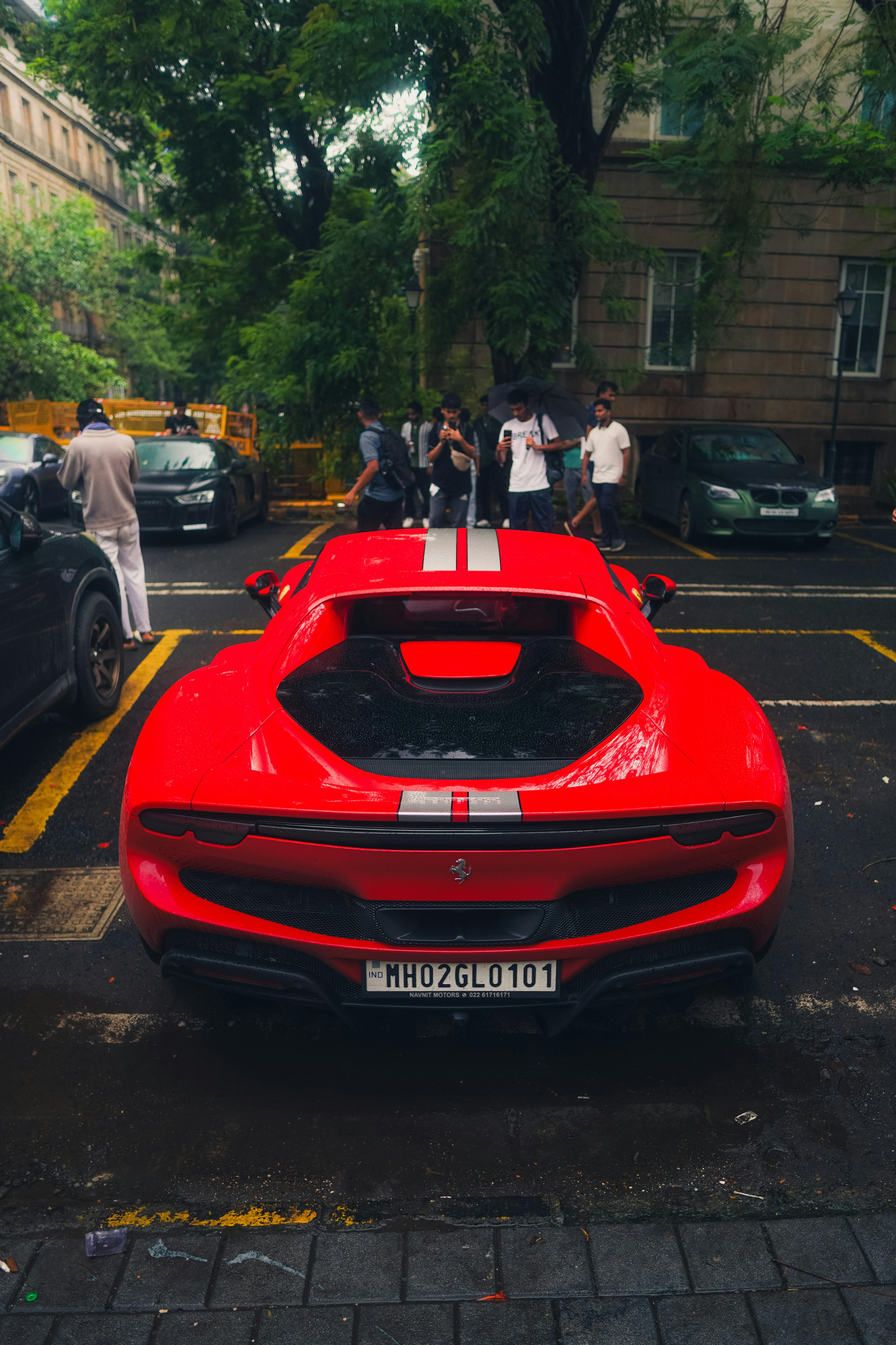 Red Ferrari Sports Car in Urban Setting · Free Stock Photo