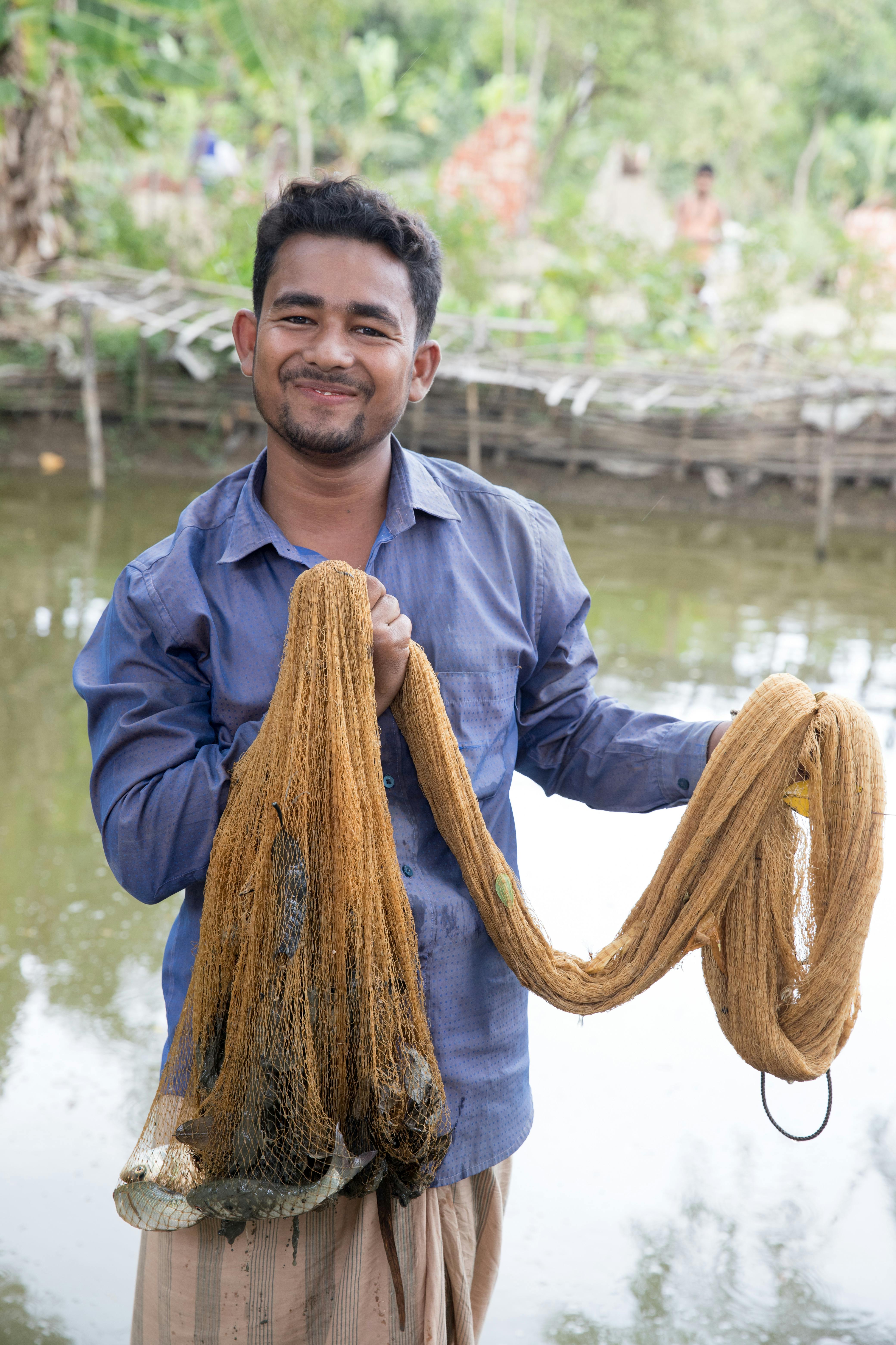 Local Fisherman Holding a Fresh Catch in Bangladesh · Free Stock Photo