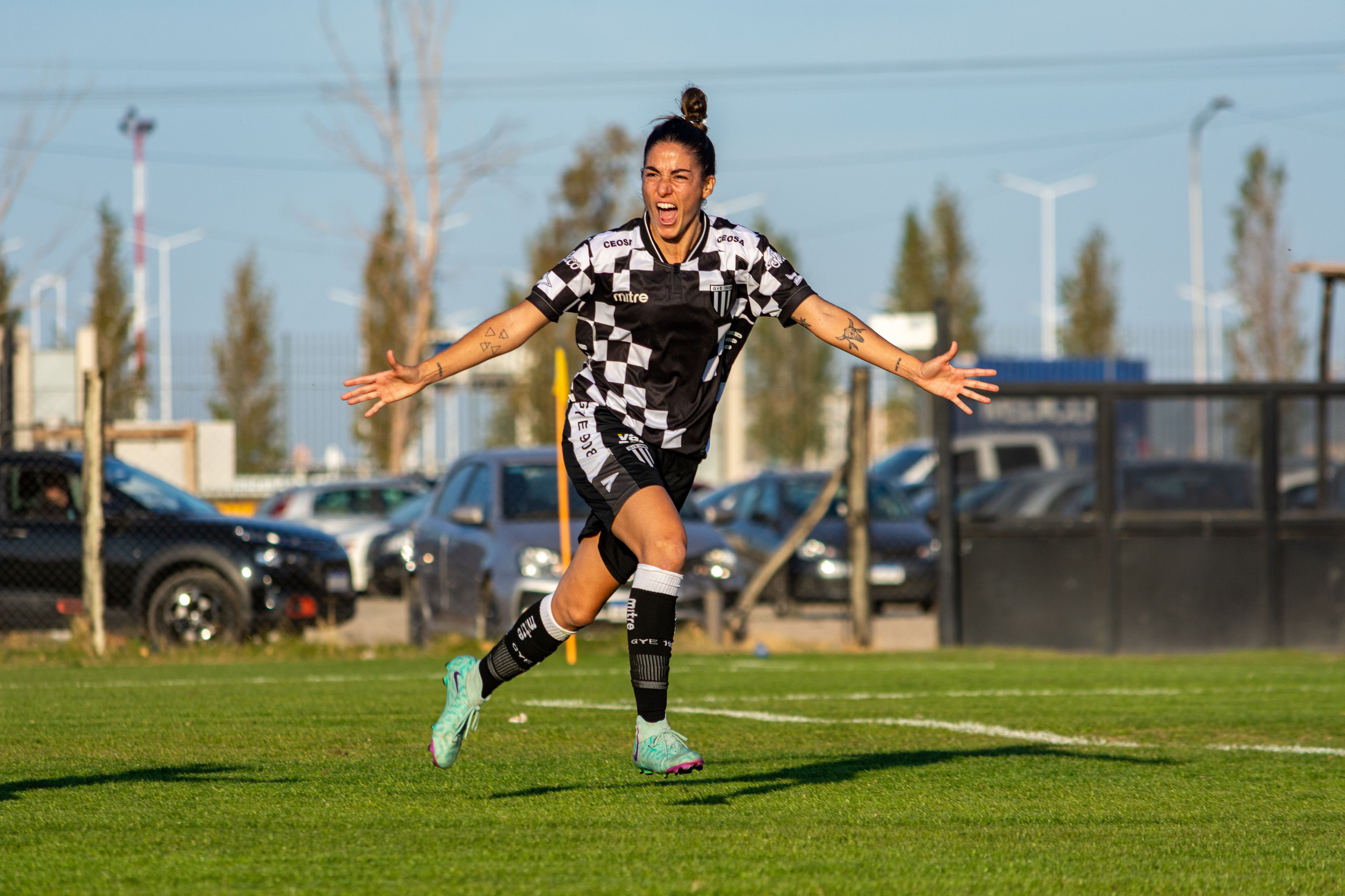 Dynamic Female Footballer Celebrating Victory Outdoors · Free Stock Photo