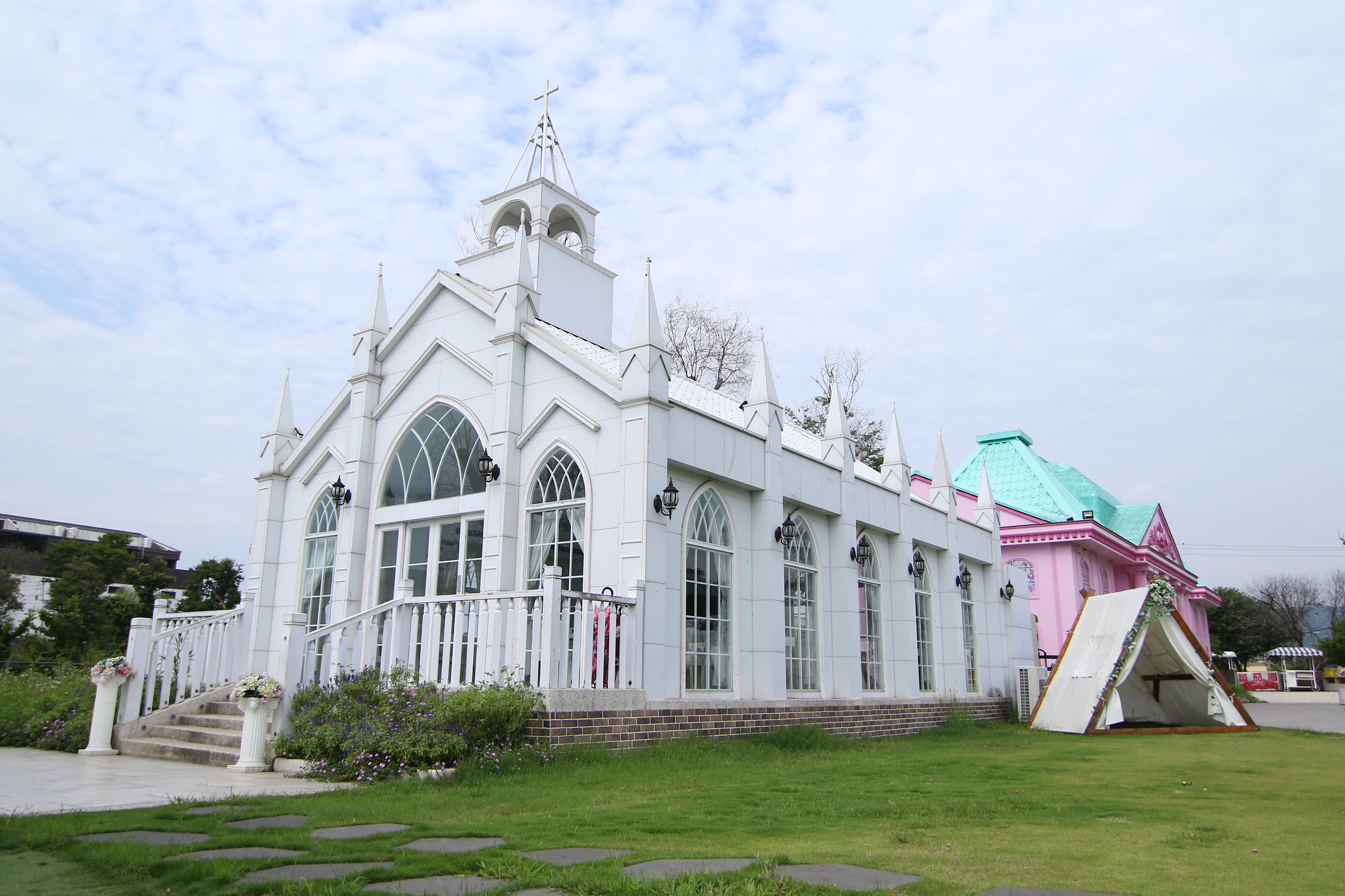Gothic Revival Chapel With Adjacent Pink Building · Free Stock Photo