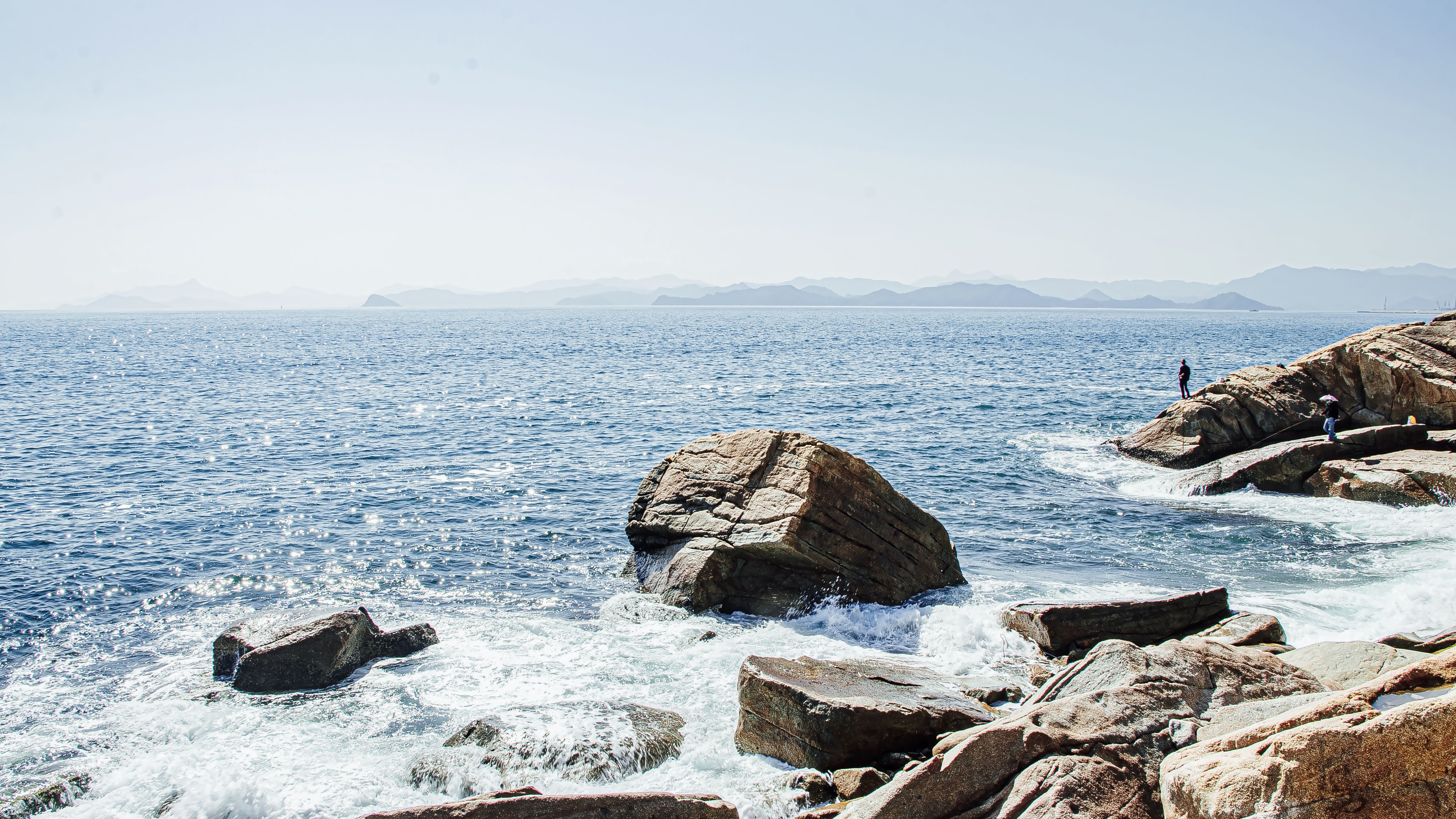 Scenic Coastal View with Rocky Shores and Distant Mountains · Free ...