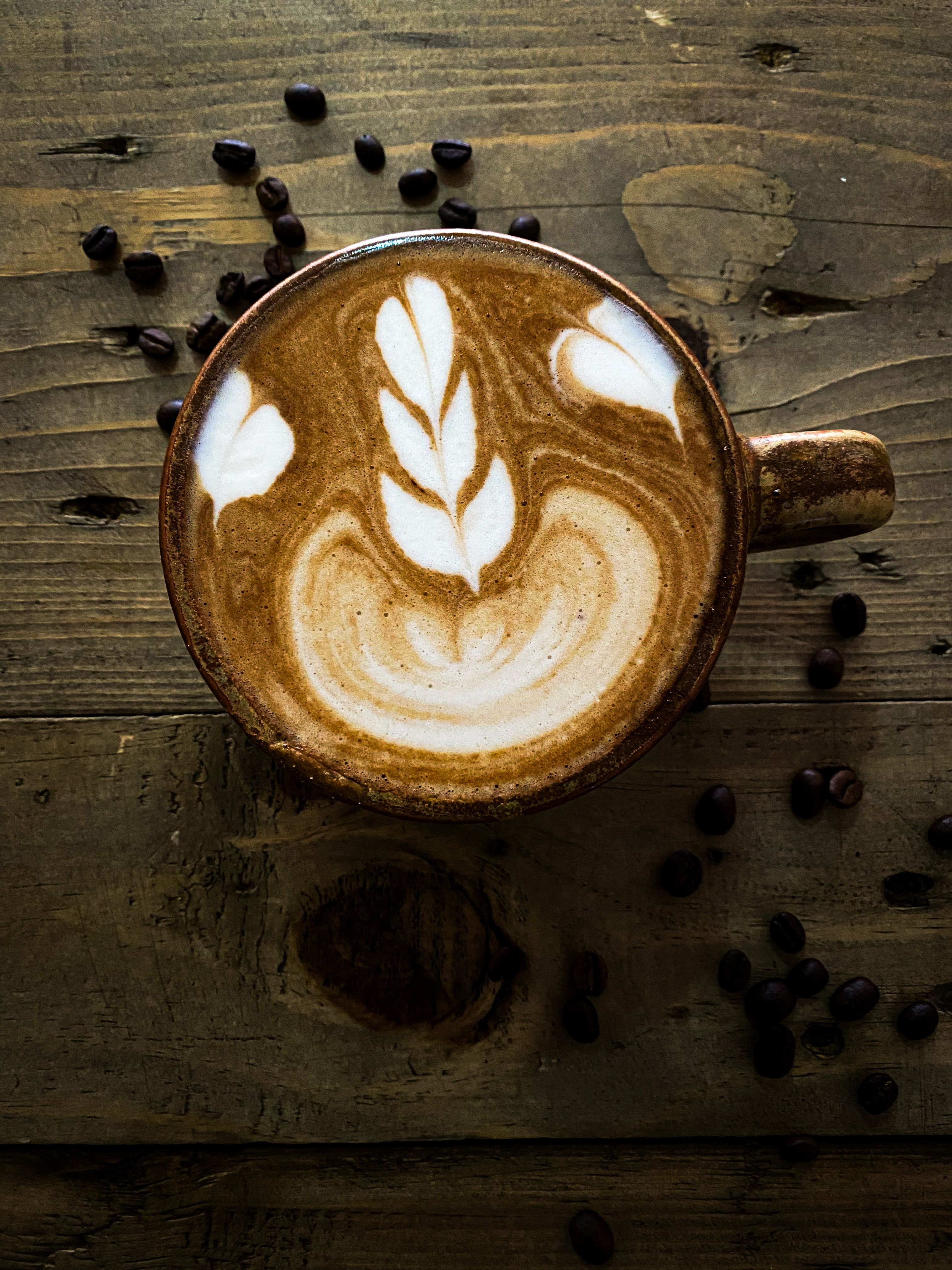 Artistic Latte with Leaf Design on Wooden Table · Free Stock Photo