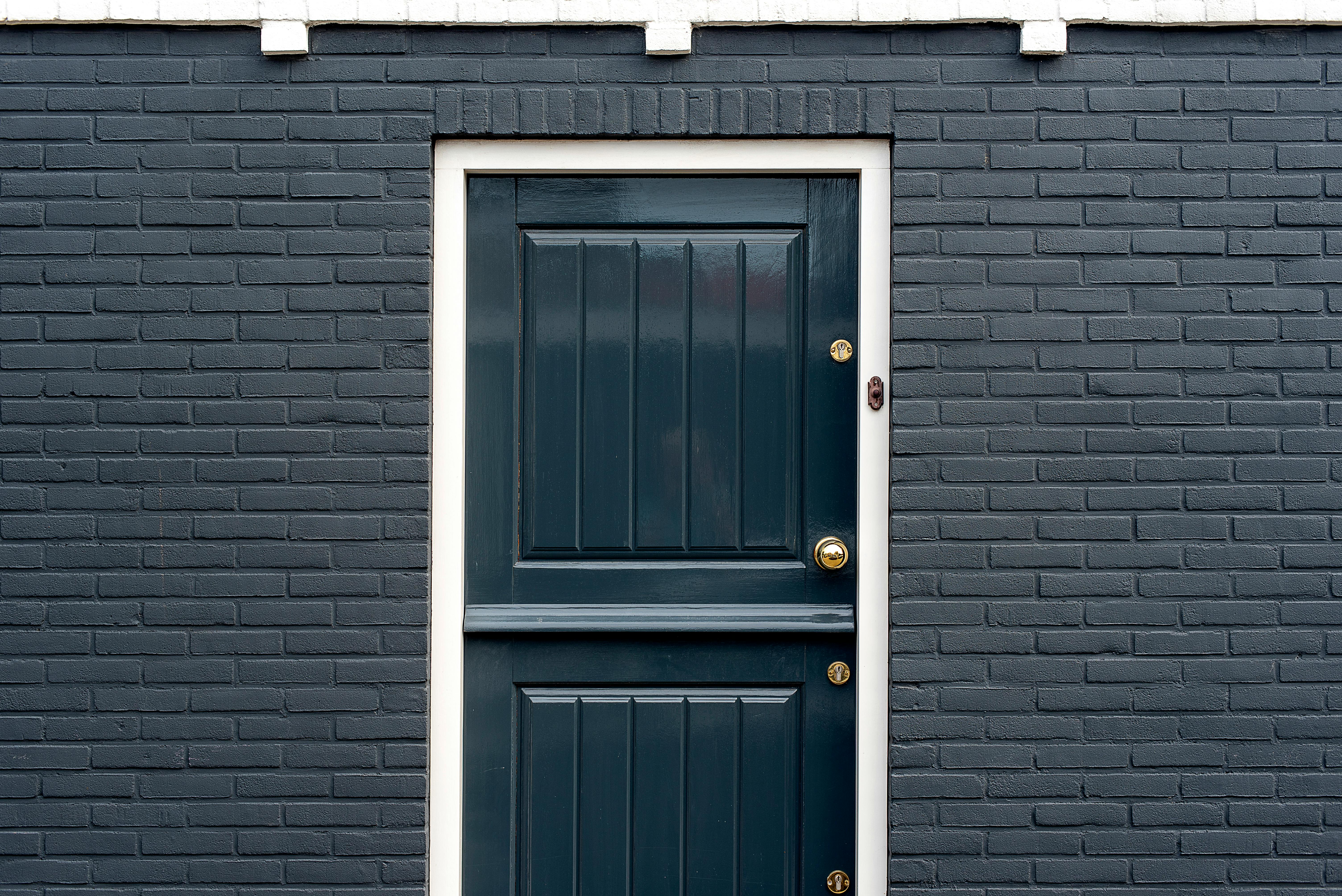 Stylish Black Door on Brick Wall Exterior · Free Stock Photo