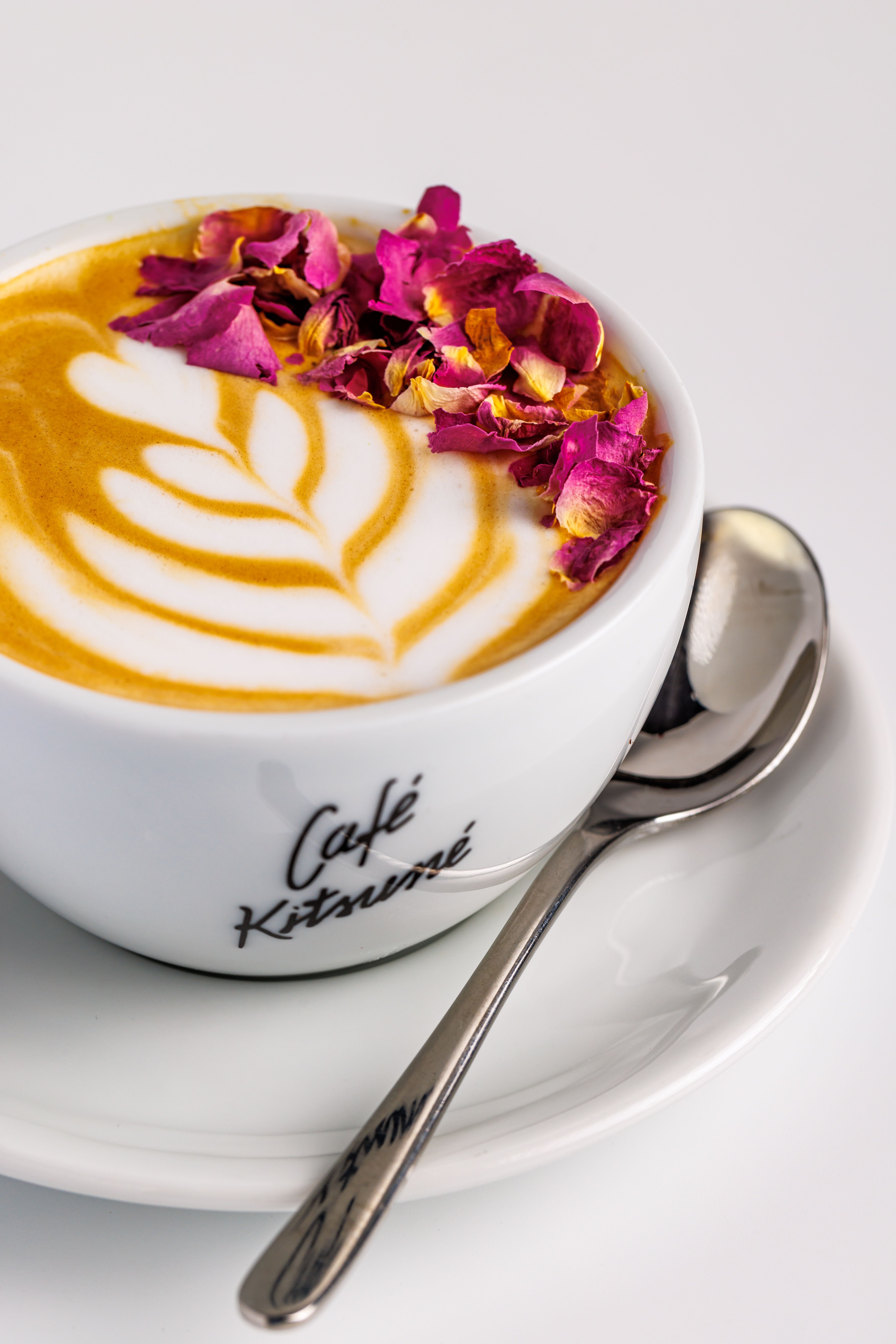 Elegant Latte Art with Rose Petals in Cafe Cup · Free Stock Photo