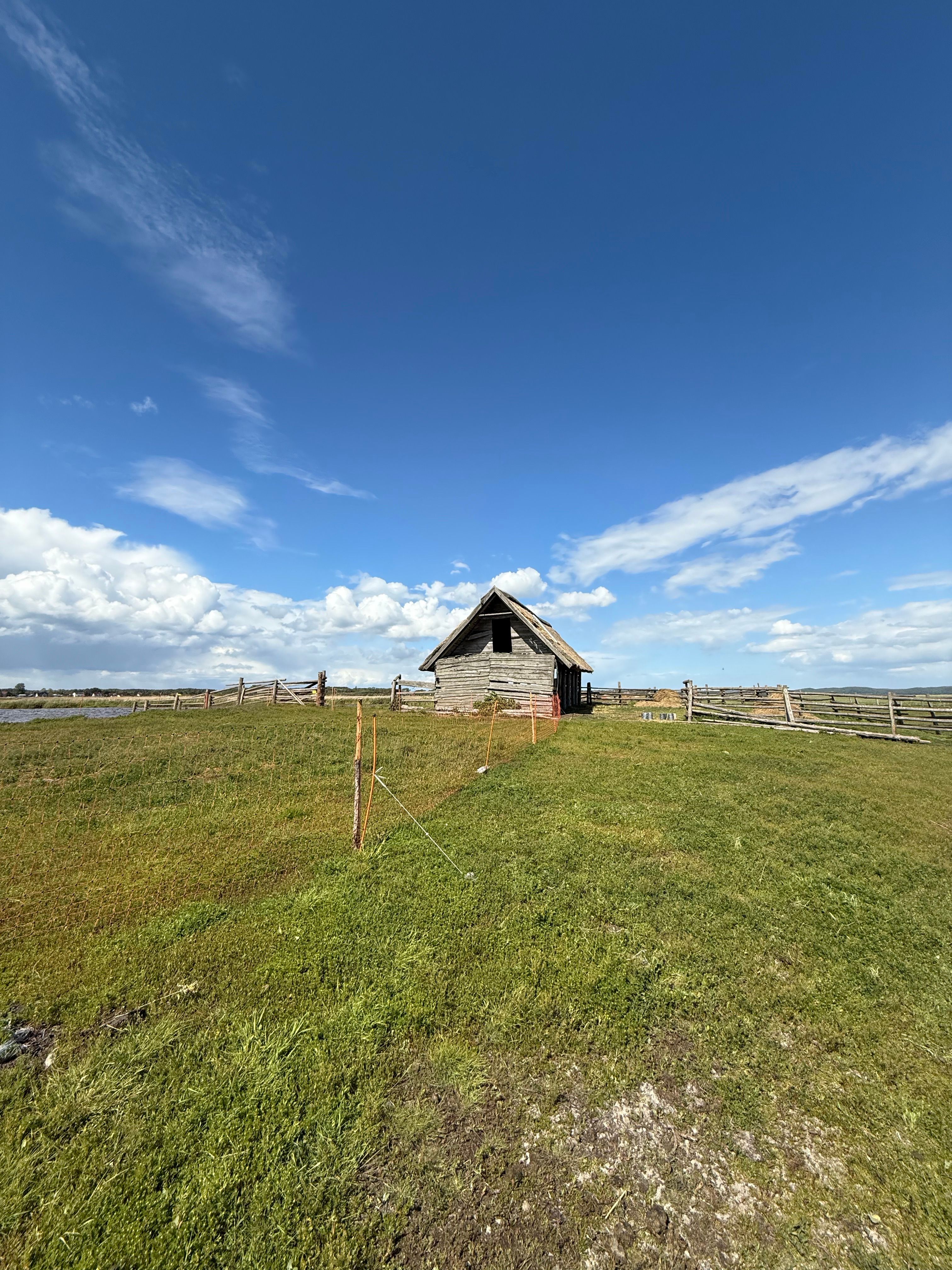 Scenic View of a Rustic Wooden Hut on Grassland · Free Stock Photo