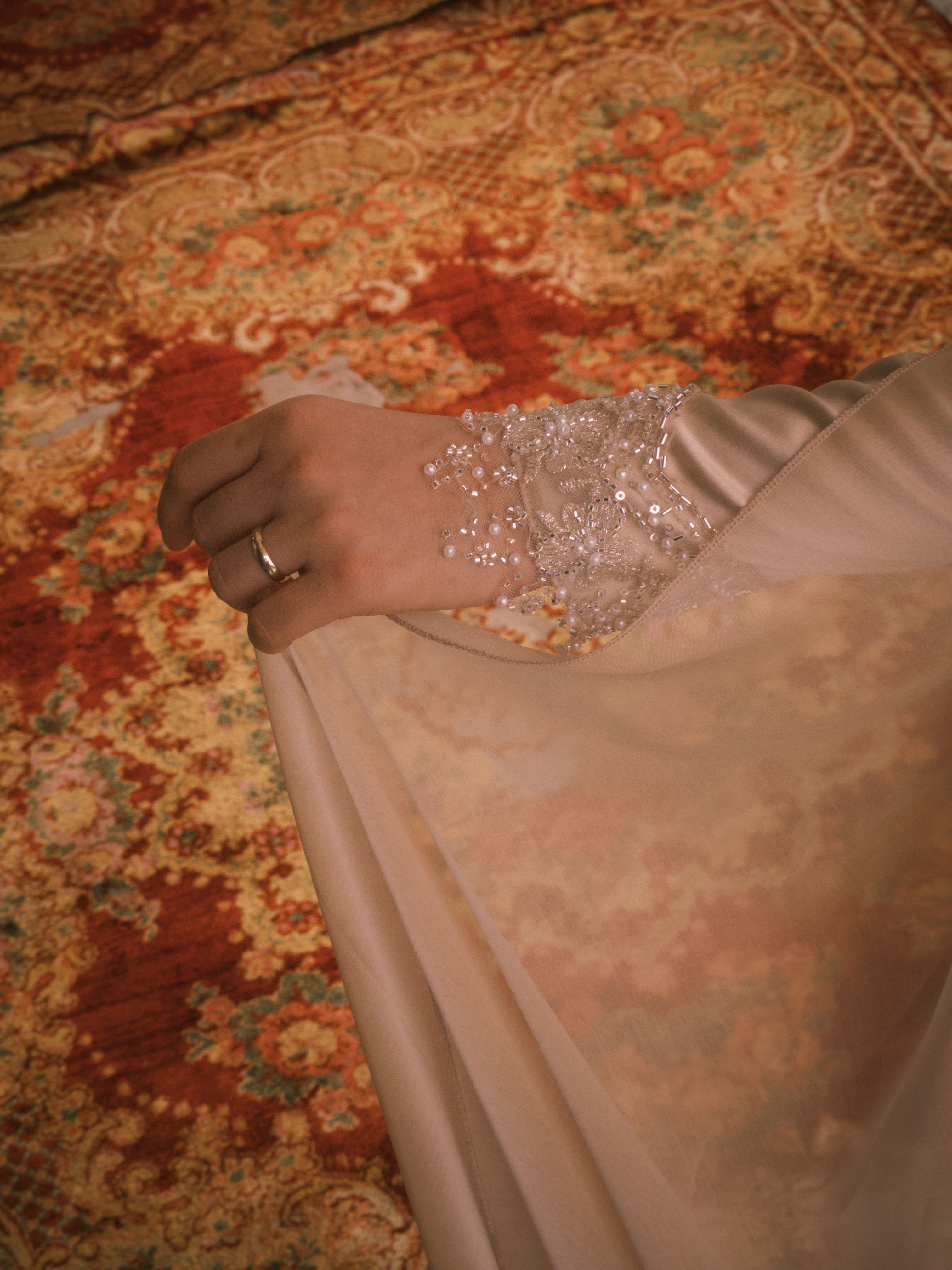 Elegant Hand with Bridal Lace on Ornate Carpet · Free Stock Photo