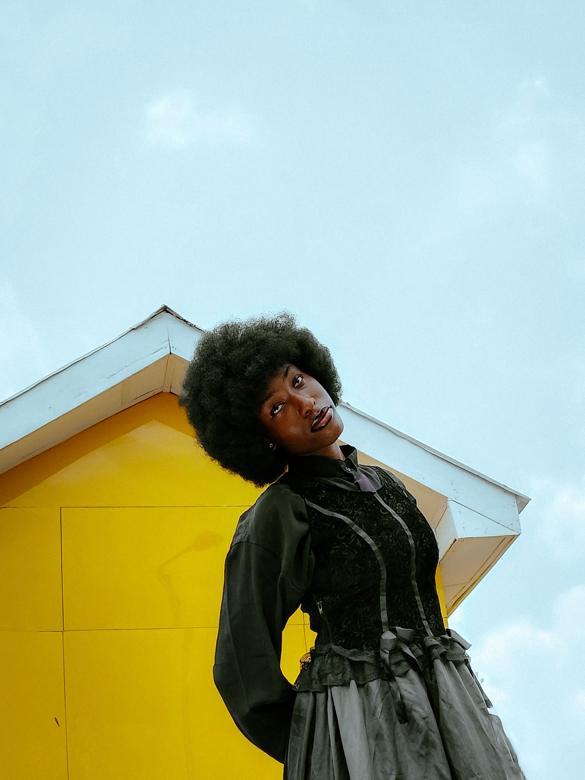 Stylish Portrait Against Vibrant Yellow Background · Free Stock Photo
