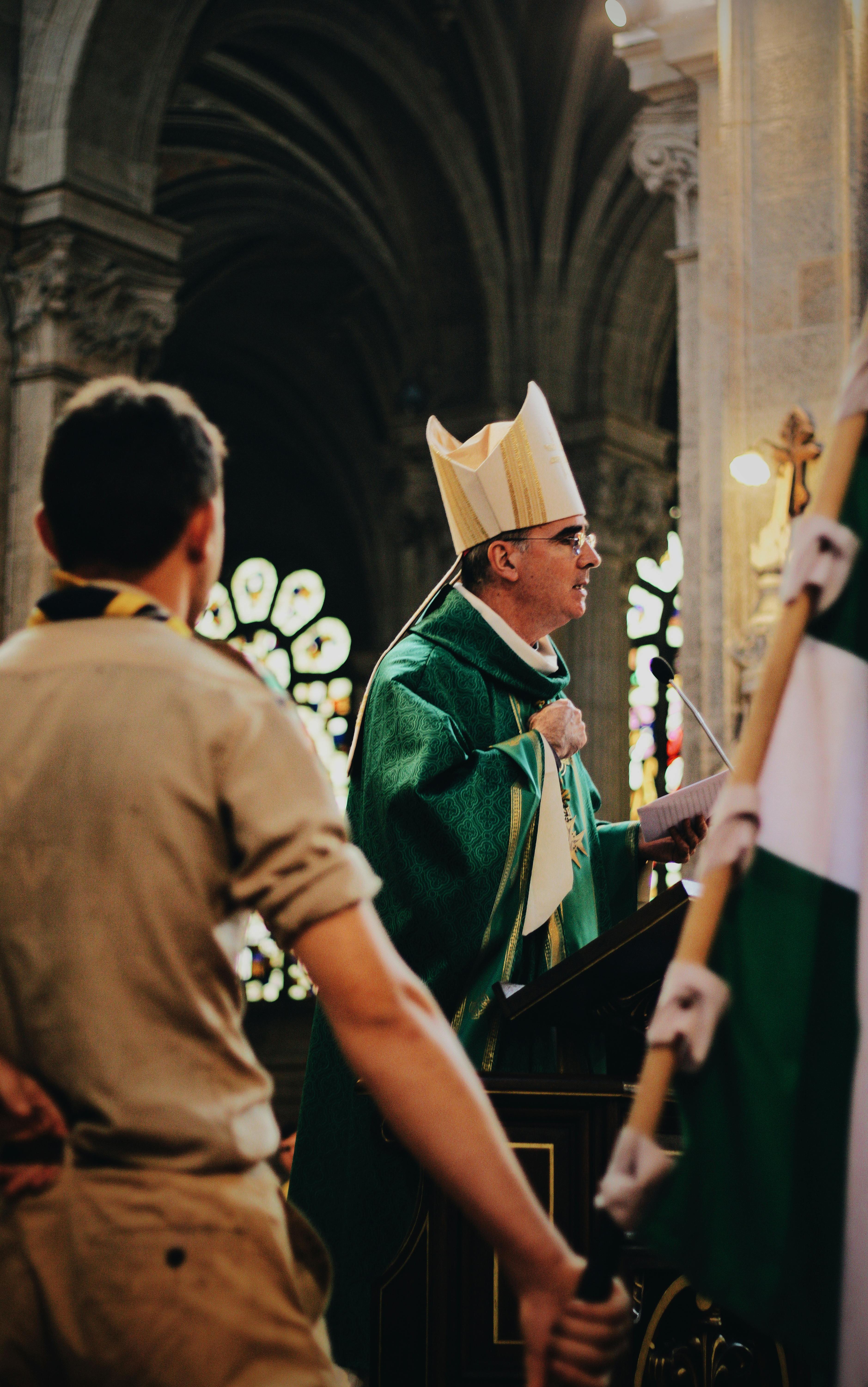 Photo of Priest Standing on Cathedral · Free Stock Photo