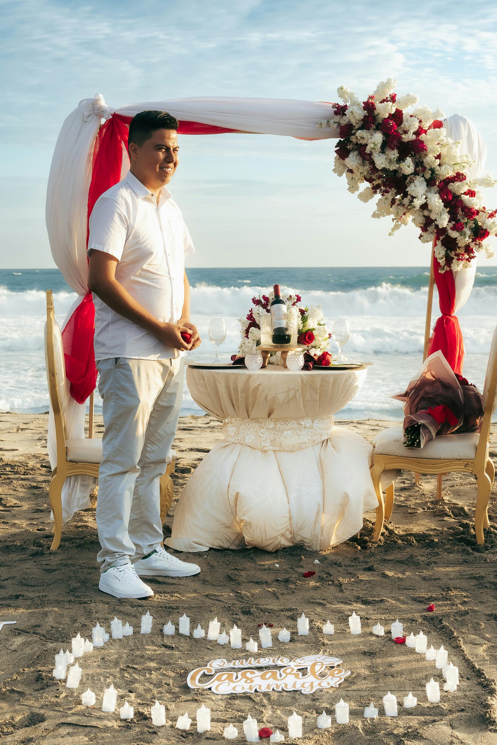 Romantic Beach Proposal Setup with Flowers and Candles · Free Stock Photo