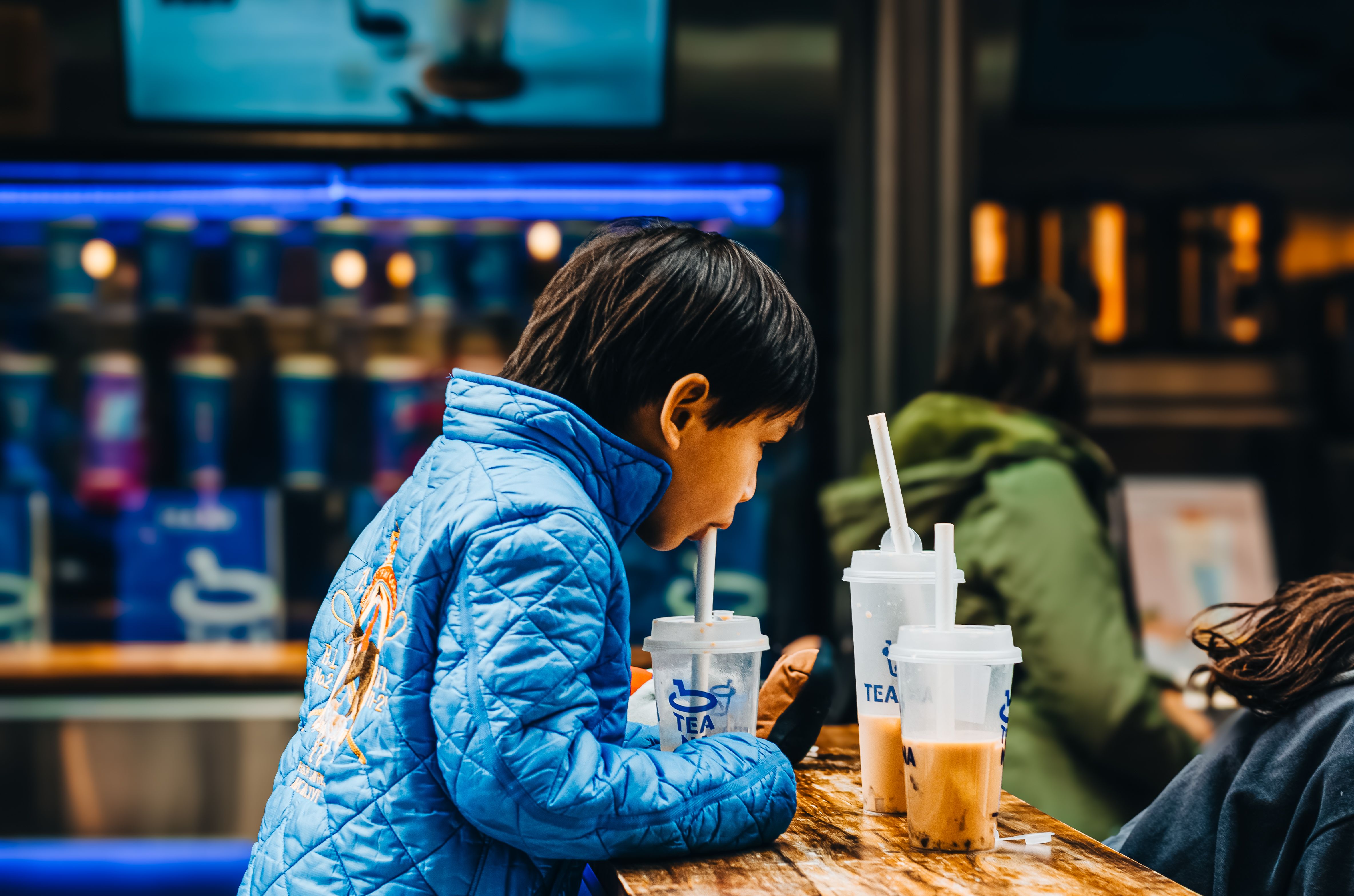 Child Enjoying Bubble Tea in Urban Setting · Free Stock Photo