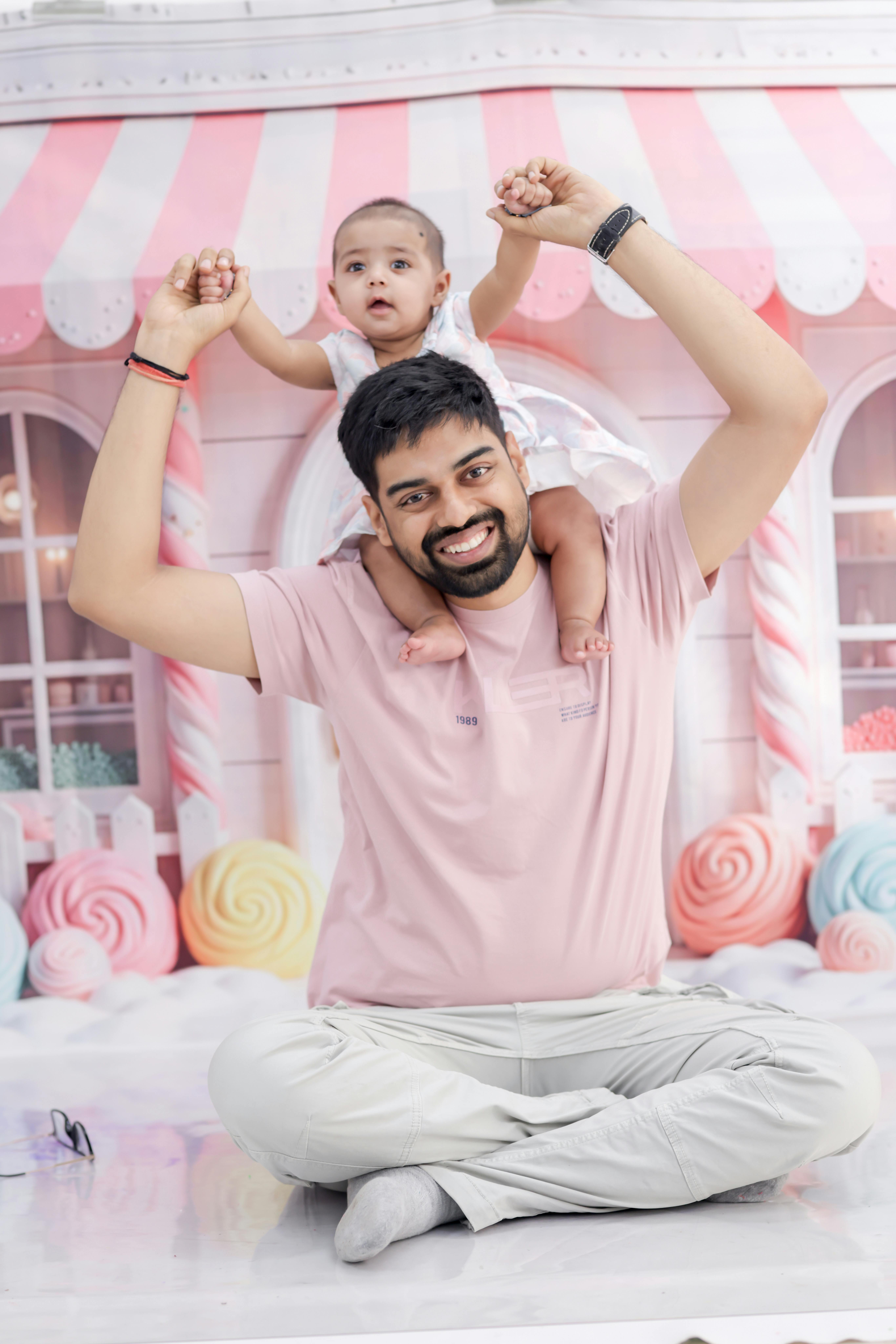 Father and Baby in Candy-Themed Studio · Free Stock Photo