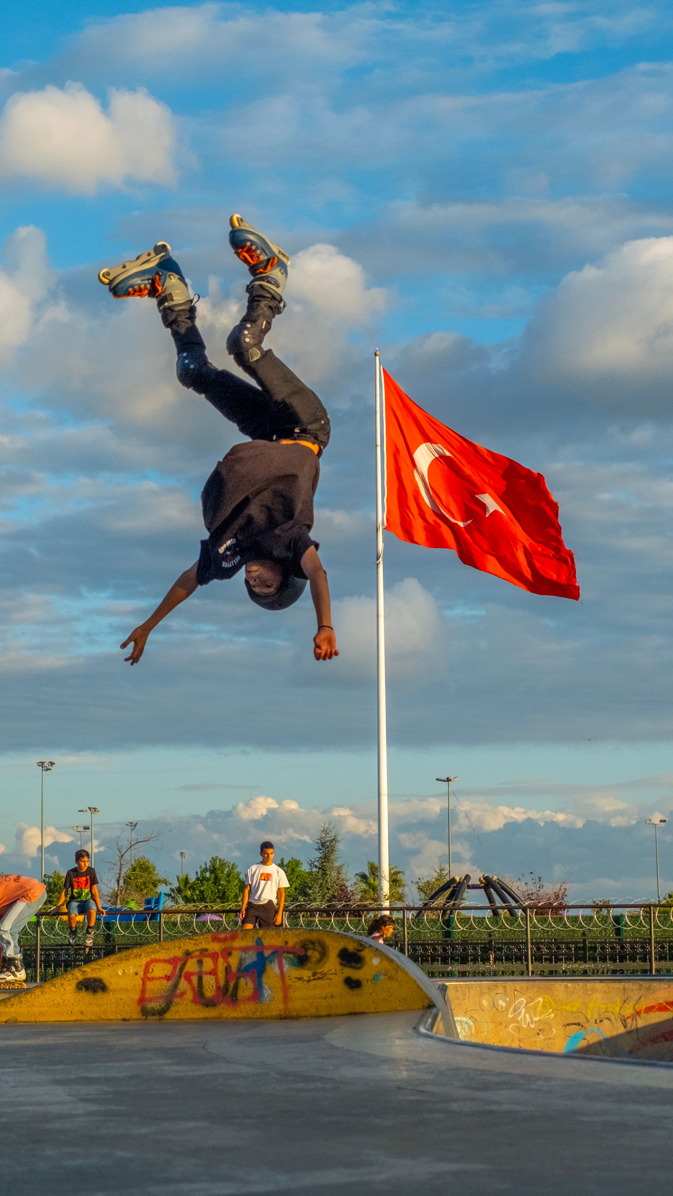 Dynamic Roller Skating Trick with Turkish Flag · Free Stock Photo