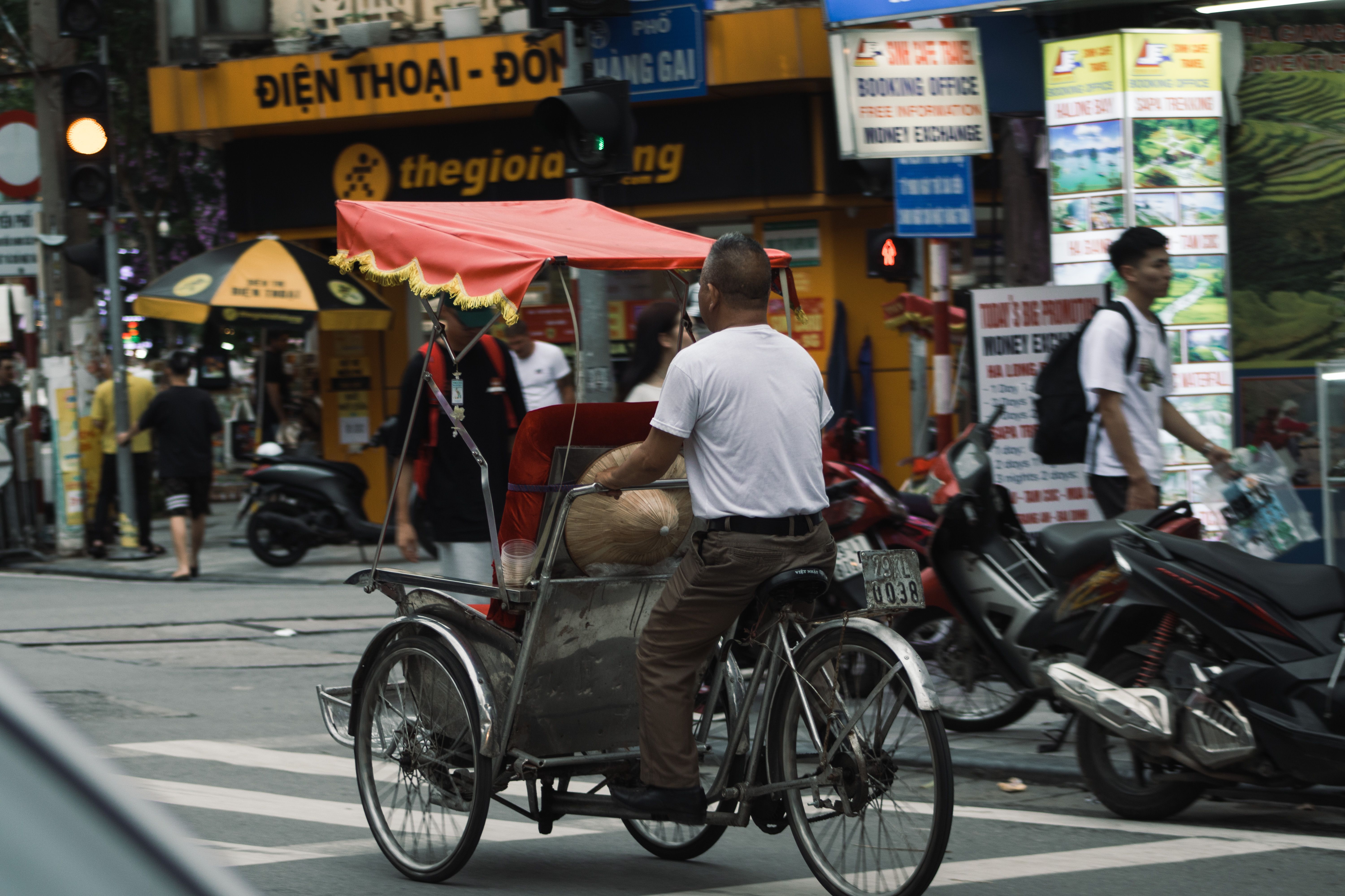 Traditional Cyclo in Busy Hanoi Street Scene · Free Stock Photo