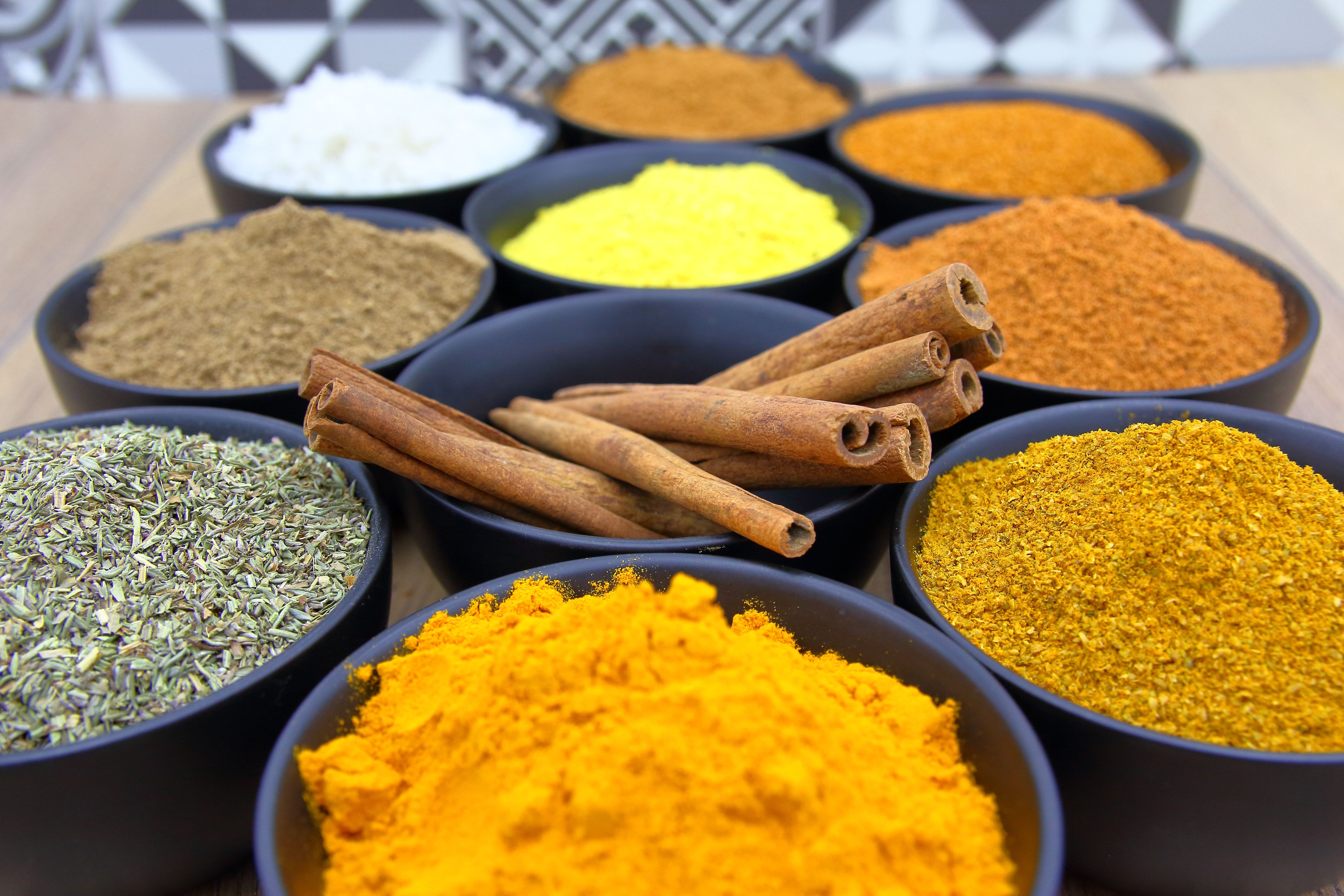 Assorted Spices in Bowls with Cinnamon Sticks · Free Stock Photo