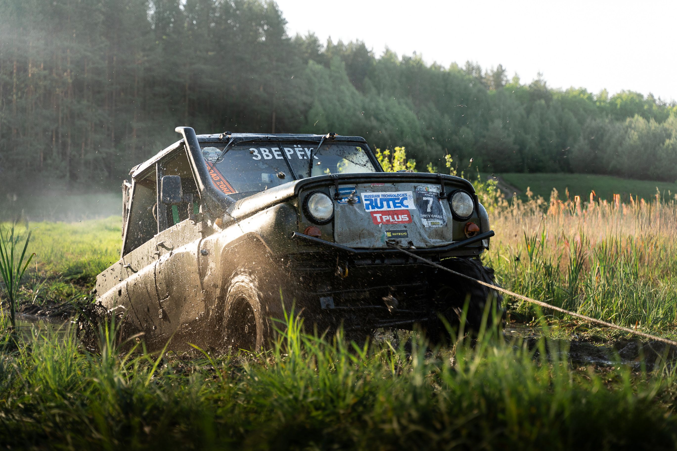 Off-Road Vehicle Navigating Muddy Terrain · Free Stock Photo
