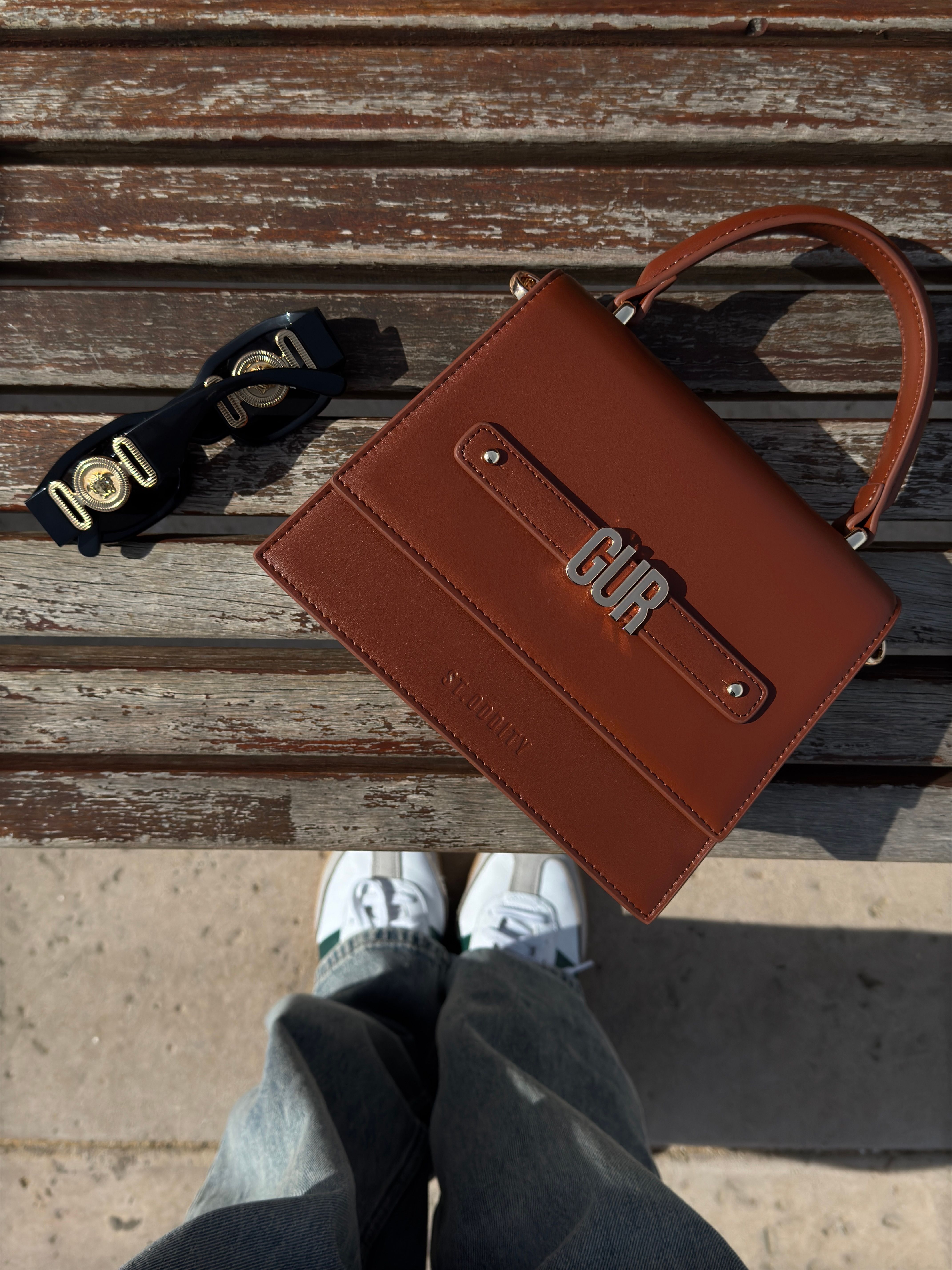 Chic Brown Leather Handbag on Wooden Bench · Free Stock Photo