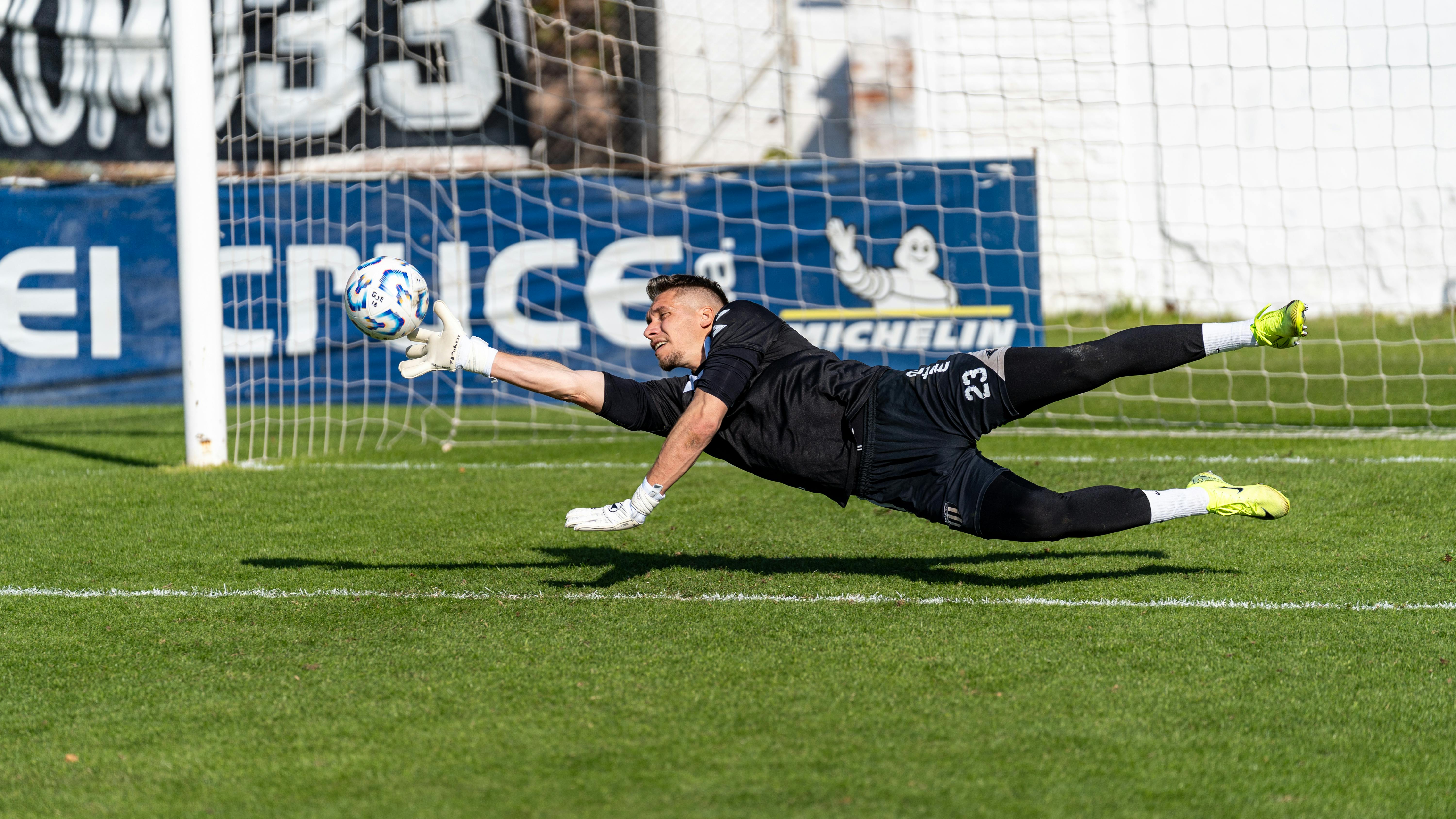 Dynamic Action Shot of a Goalkeeper Making a Save · Free Stock Photo