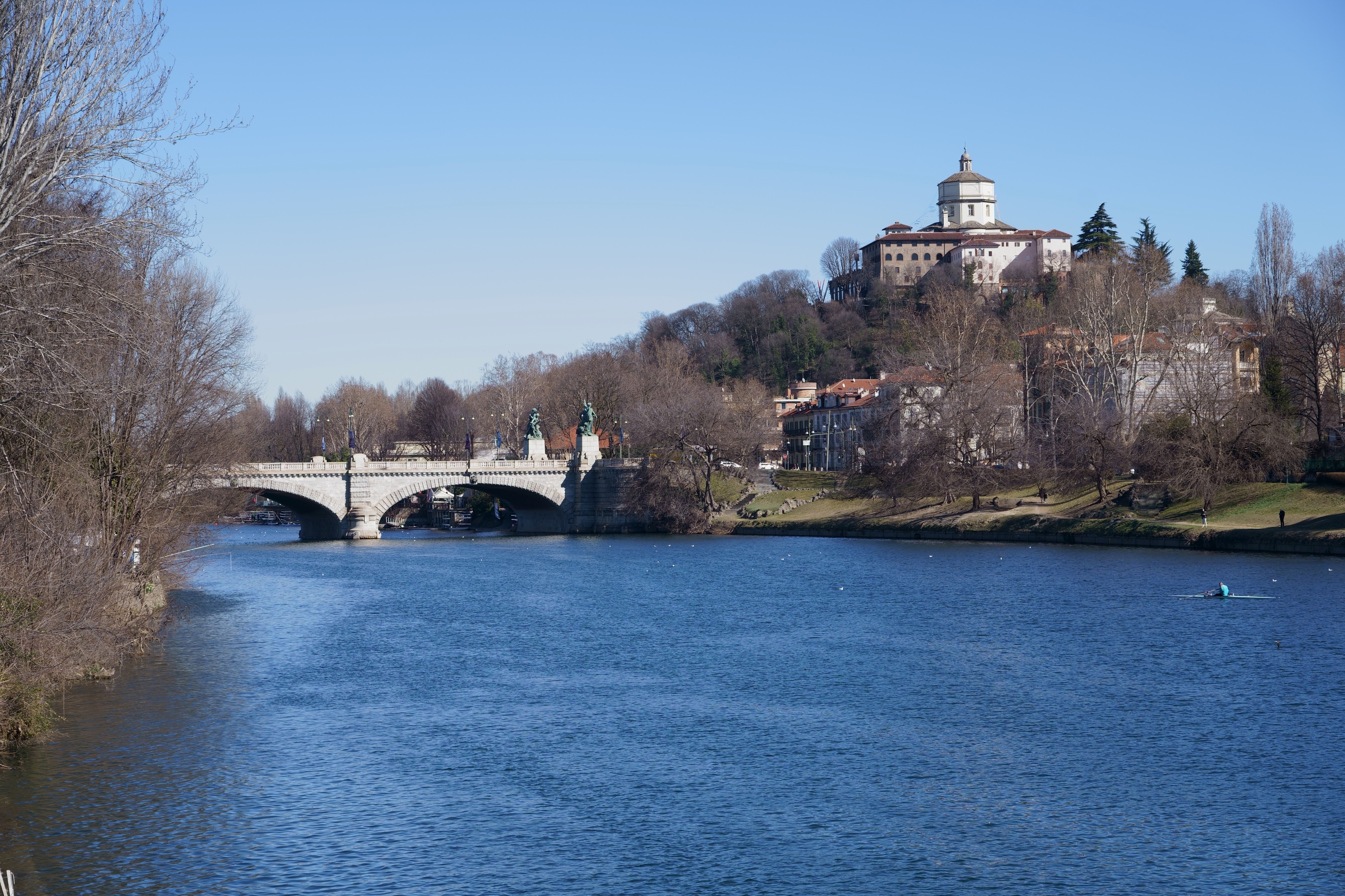 Riverbank View with Historical Architecture · Free Stock Photo