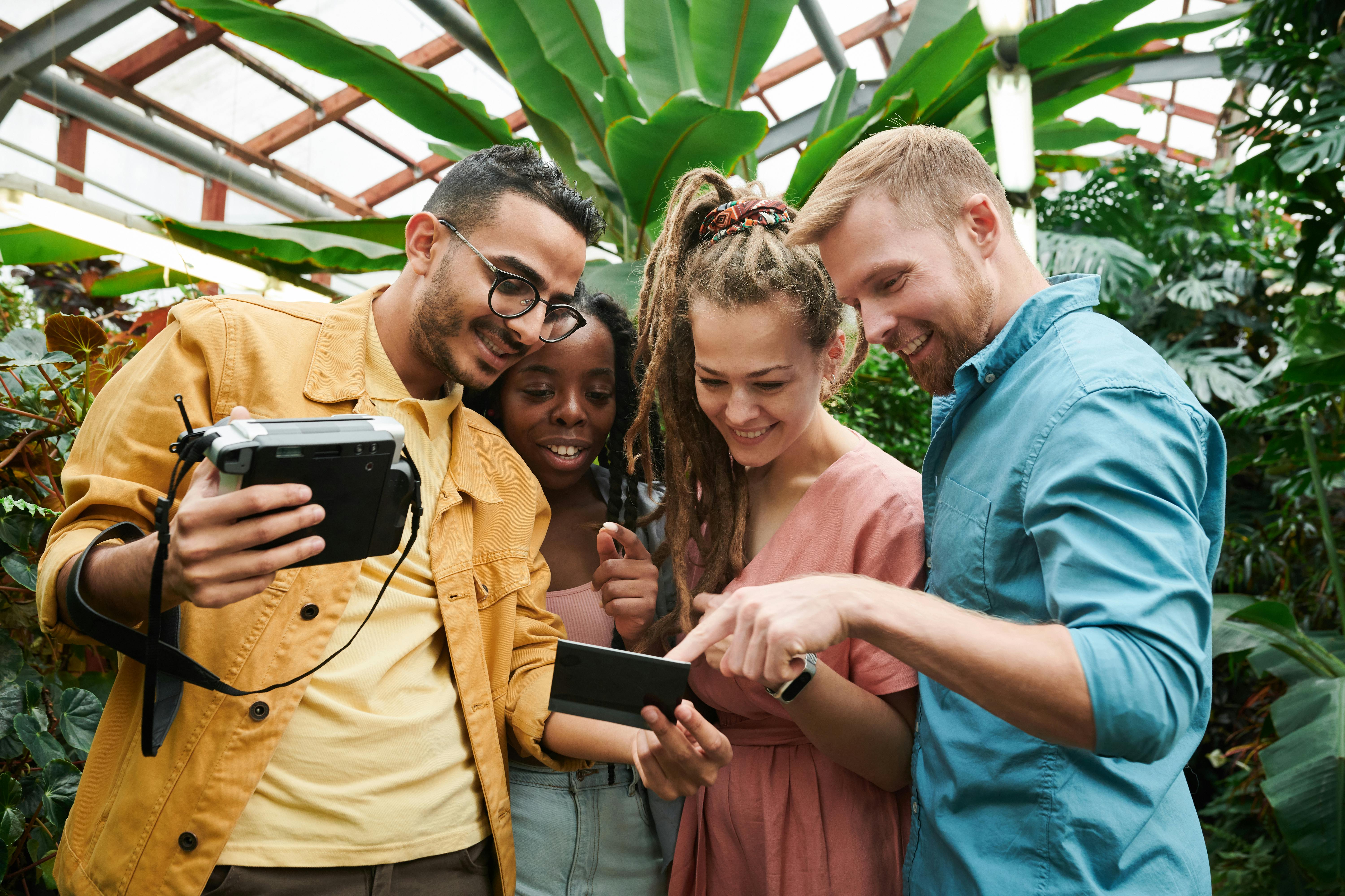 Photo Of People Looking At Photograph · Free Stock Photo